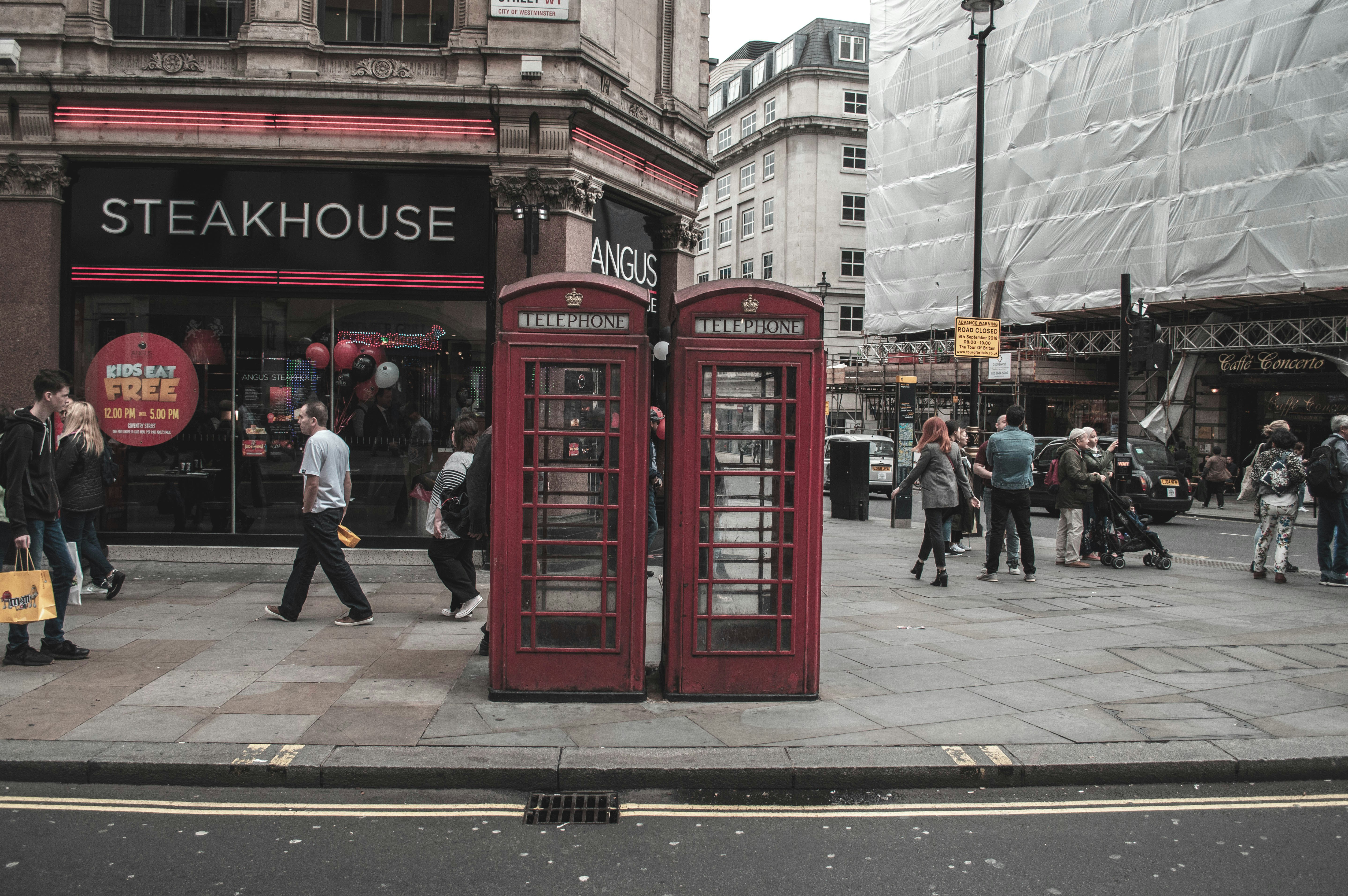 Red Telegraphs on a Busy Street Corner