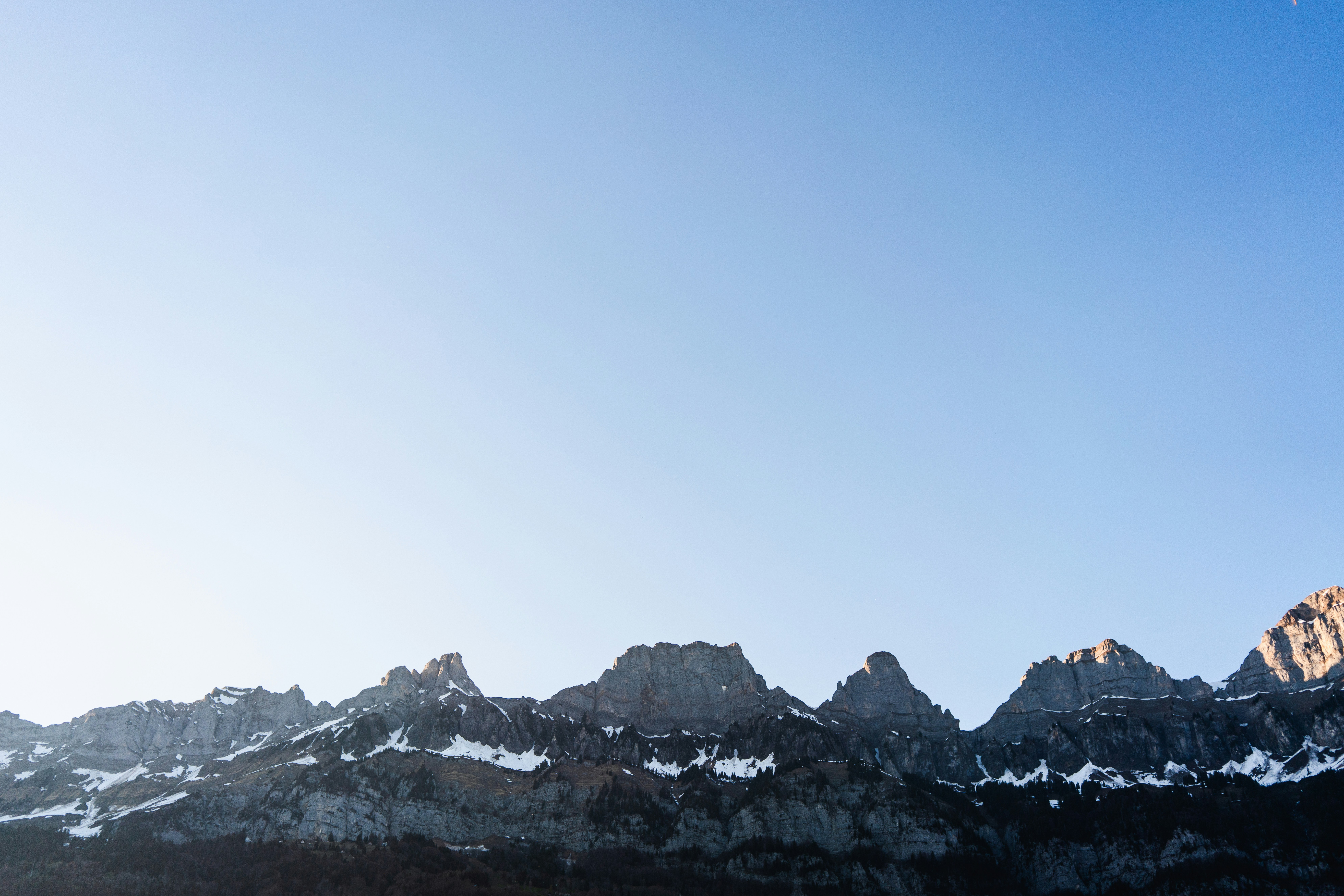 Azure Sky Over a Snow-Dusted Alpine Crest
