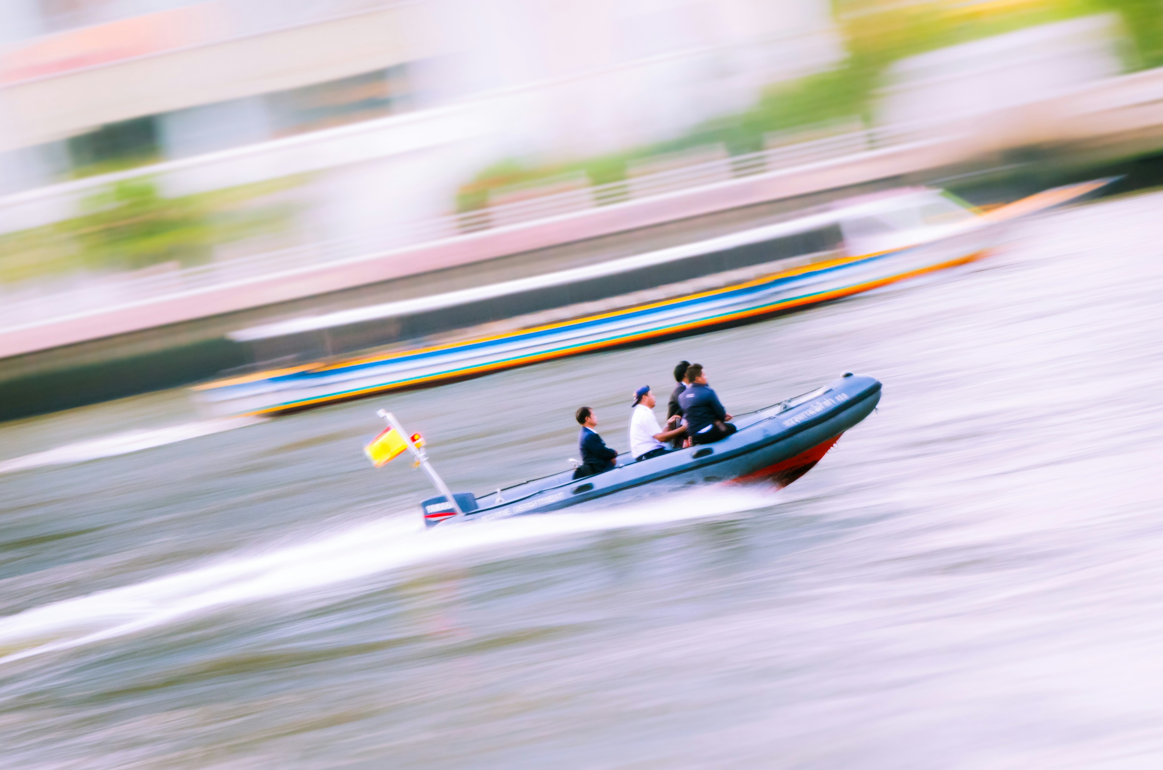 High-Speed Boat Sprint Across a Blurred Waterfront