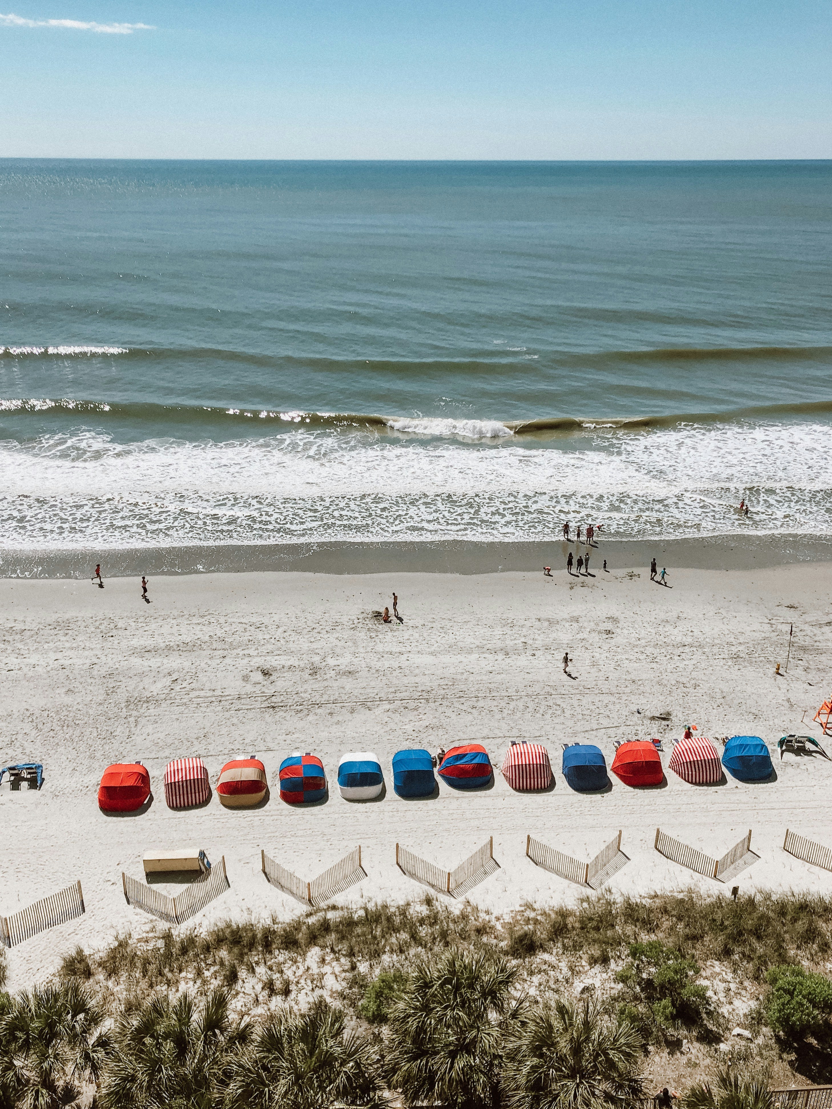 Row of Colorful Beach Umbrellas Anchoring a Quiet Shoreline