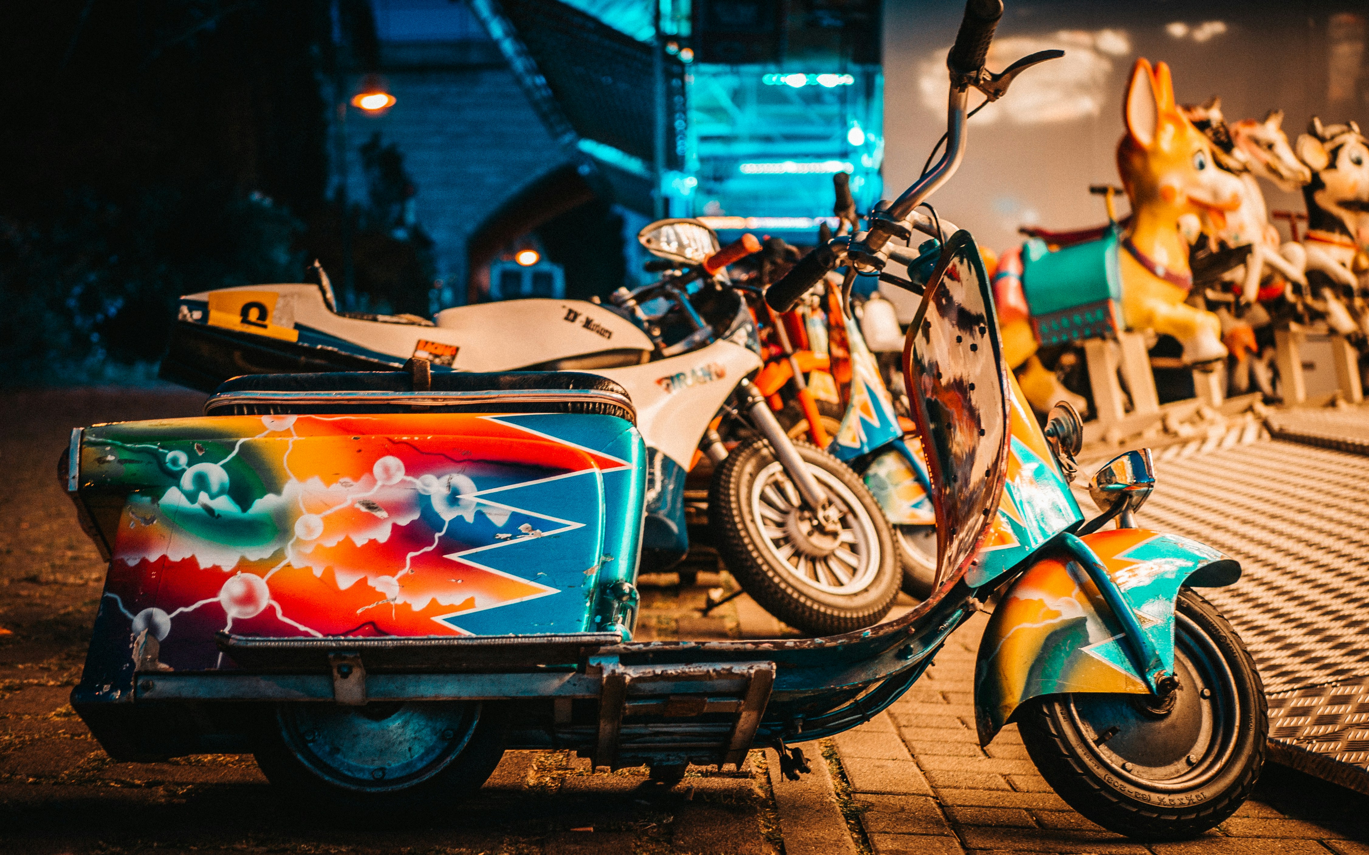 Vivid Scooter Parade: Neon Paint and Motion at Night