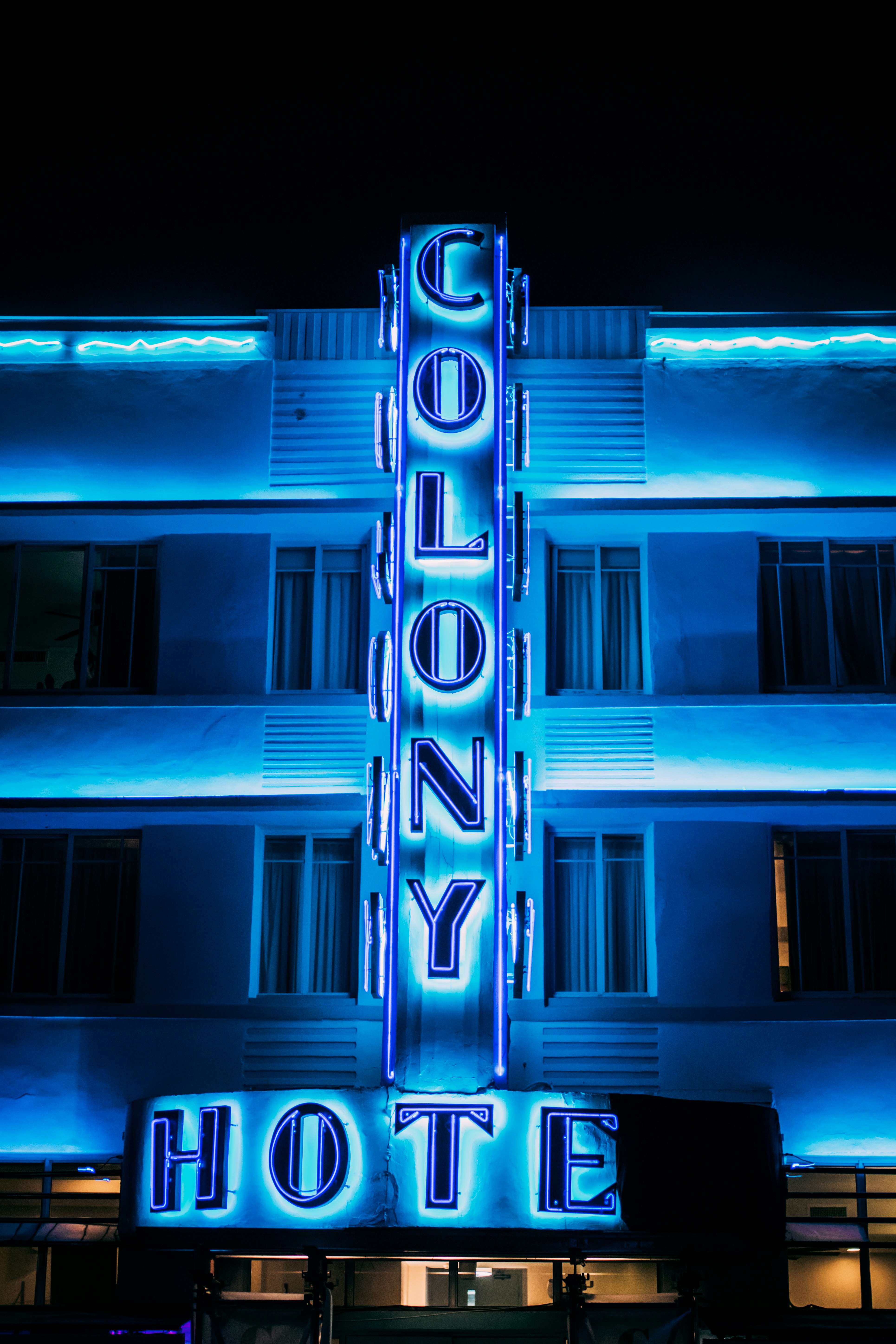 Electric Blue Vertical: The Colony Hotel Neon Sign at Midnight