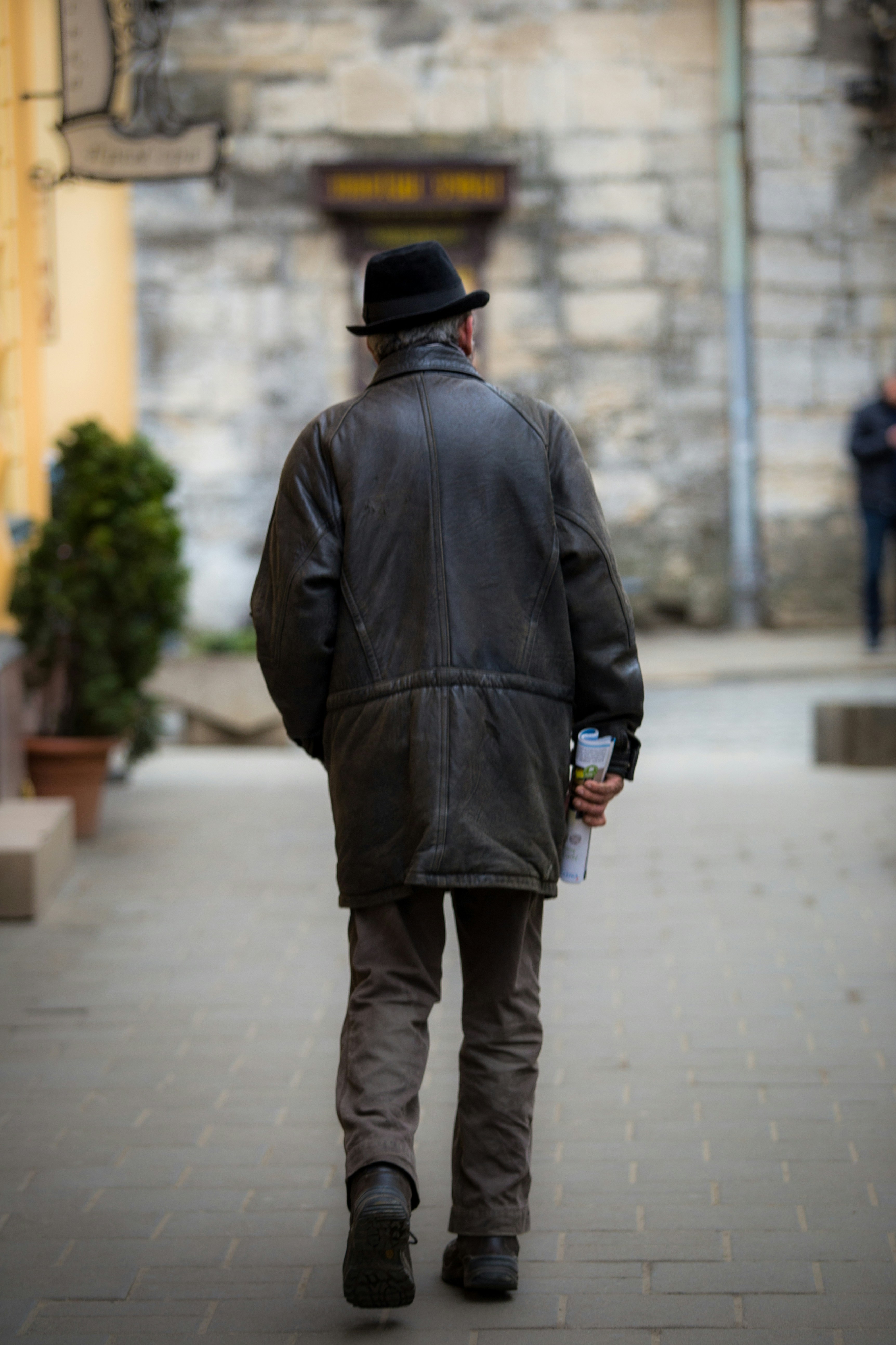 Man wearing grey coat and fedora walking on street photo – Free Grey ...