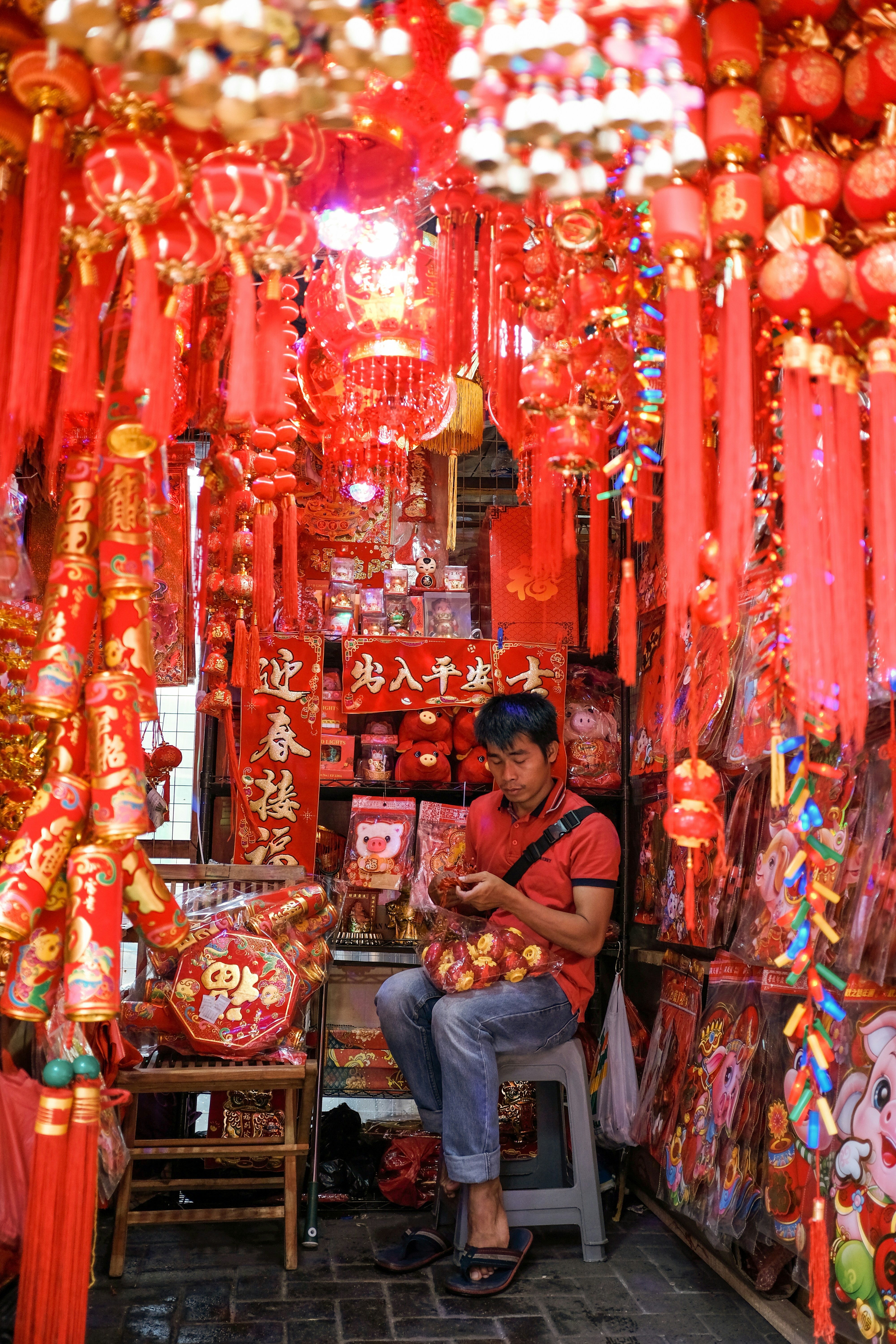 man wearing blue jeans sitting on lantern store