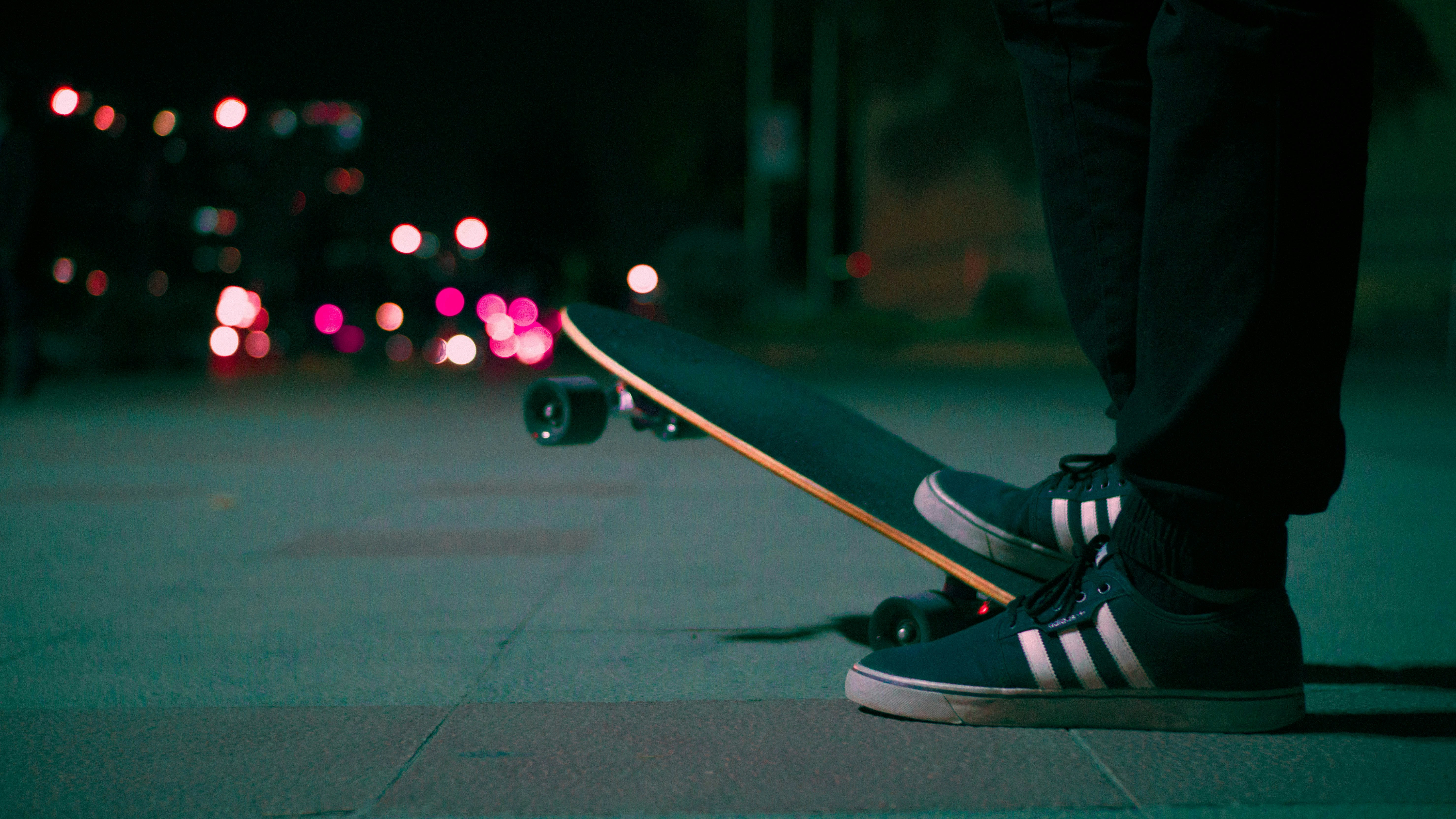 Neon Quiet: Skateboard and Sneaker Anchor a Night Street Scene