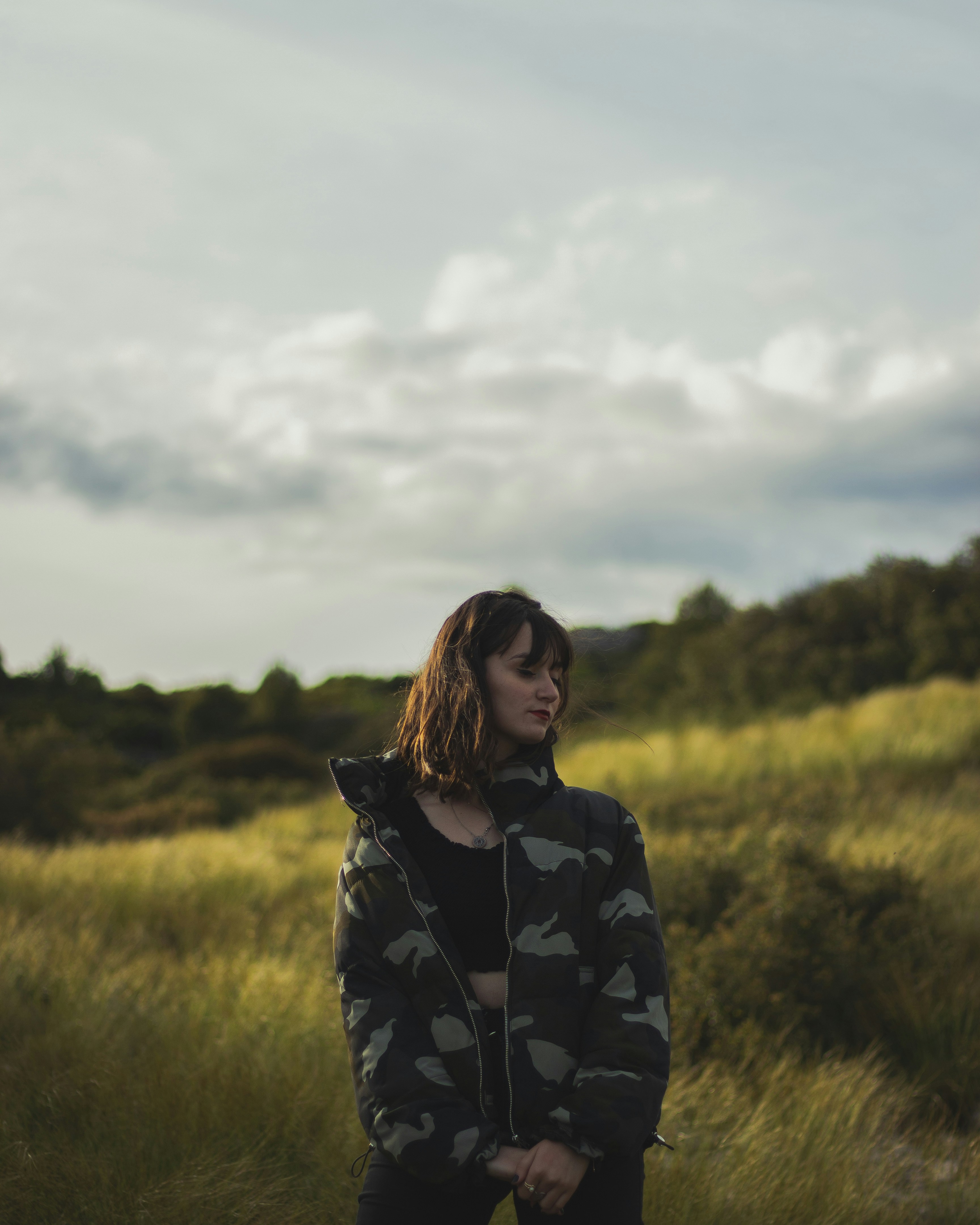 Woman standing on green field glancing her right side photo – Free ...
