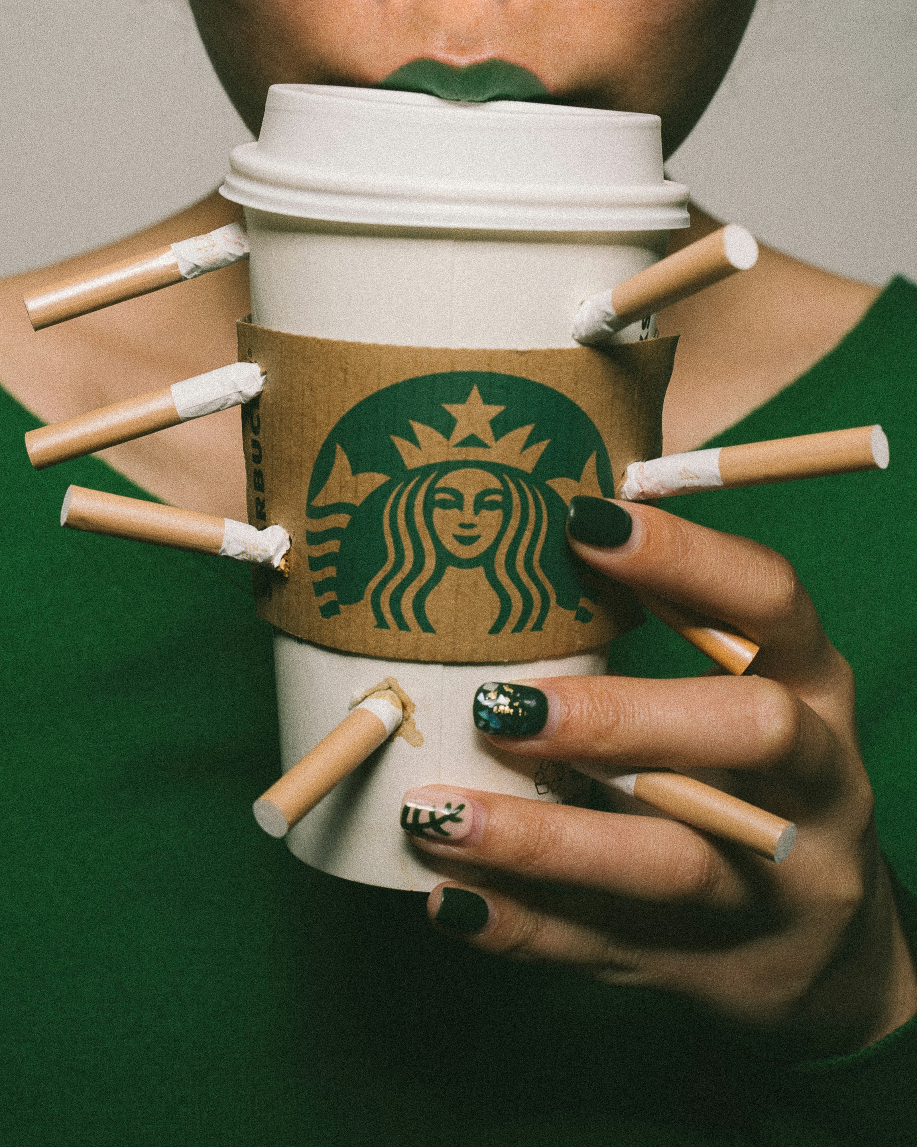 White Starbucks coffee cup surrounded with cigarette sticks photo ...