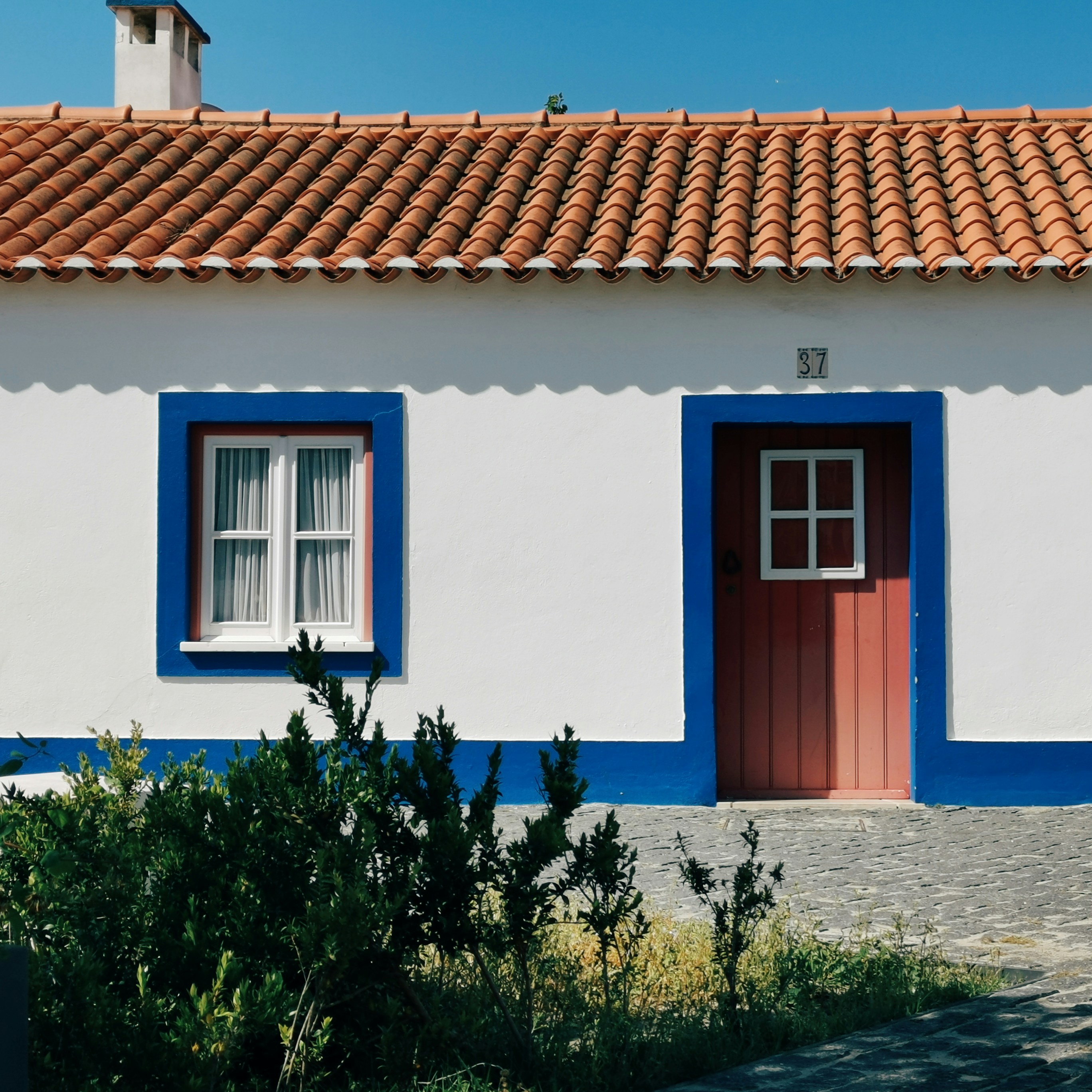 Indigo Frames, Red Door: Sunlit Portuguese Cottage
