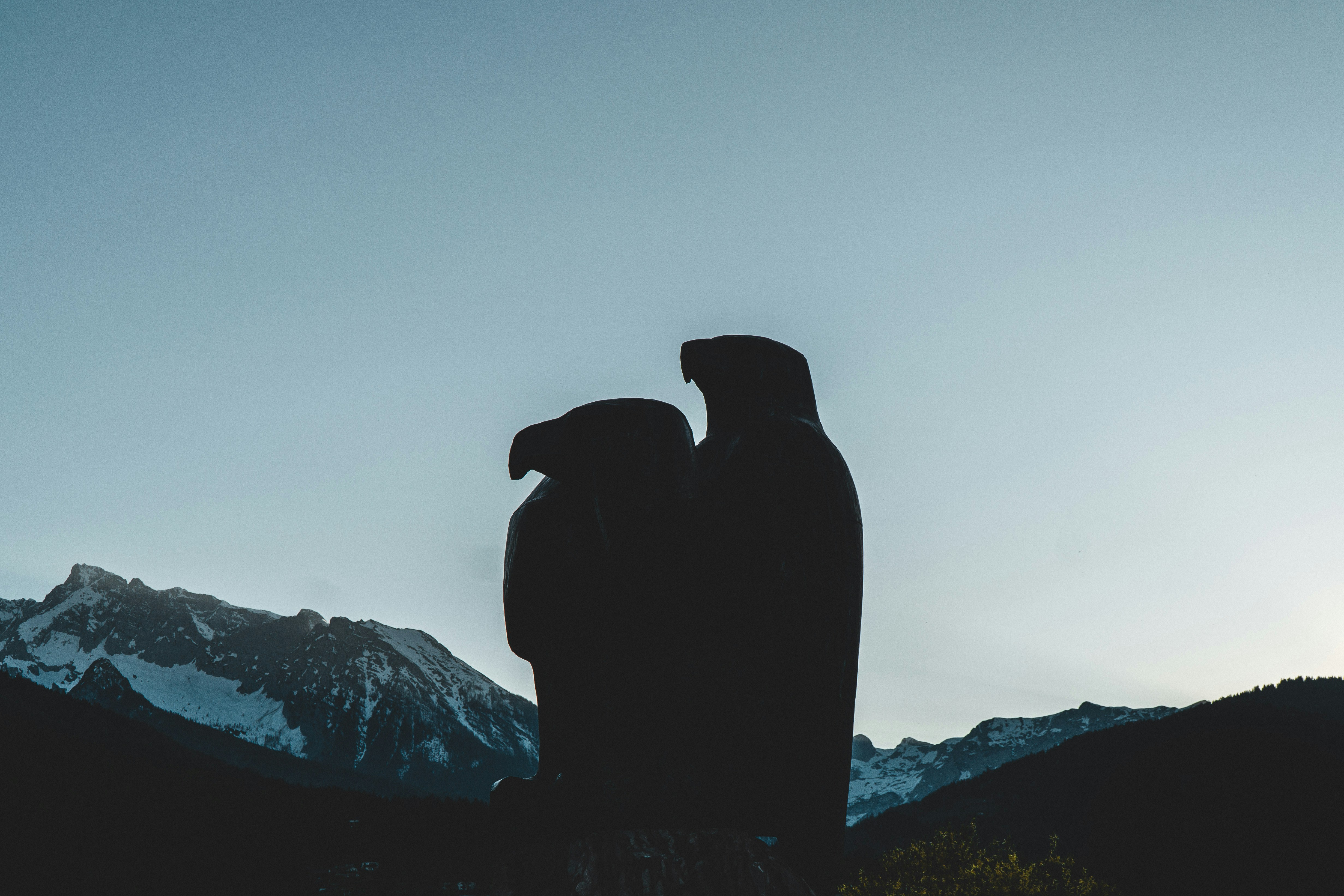 Twin Silhouettes Over a Snowbound Ridge at Dusk