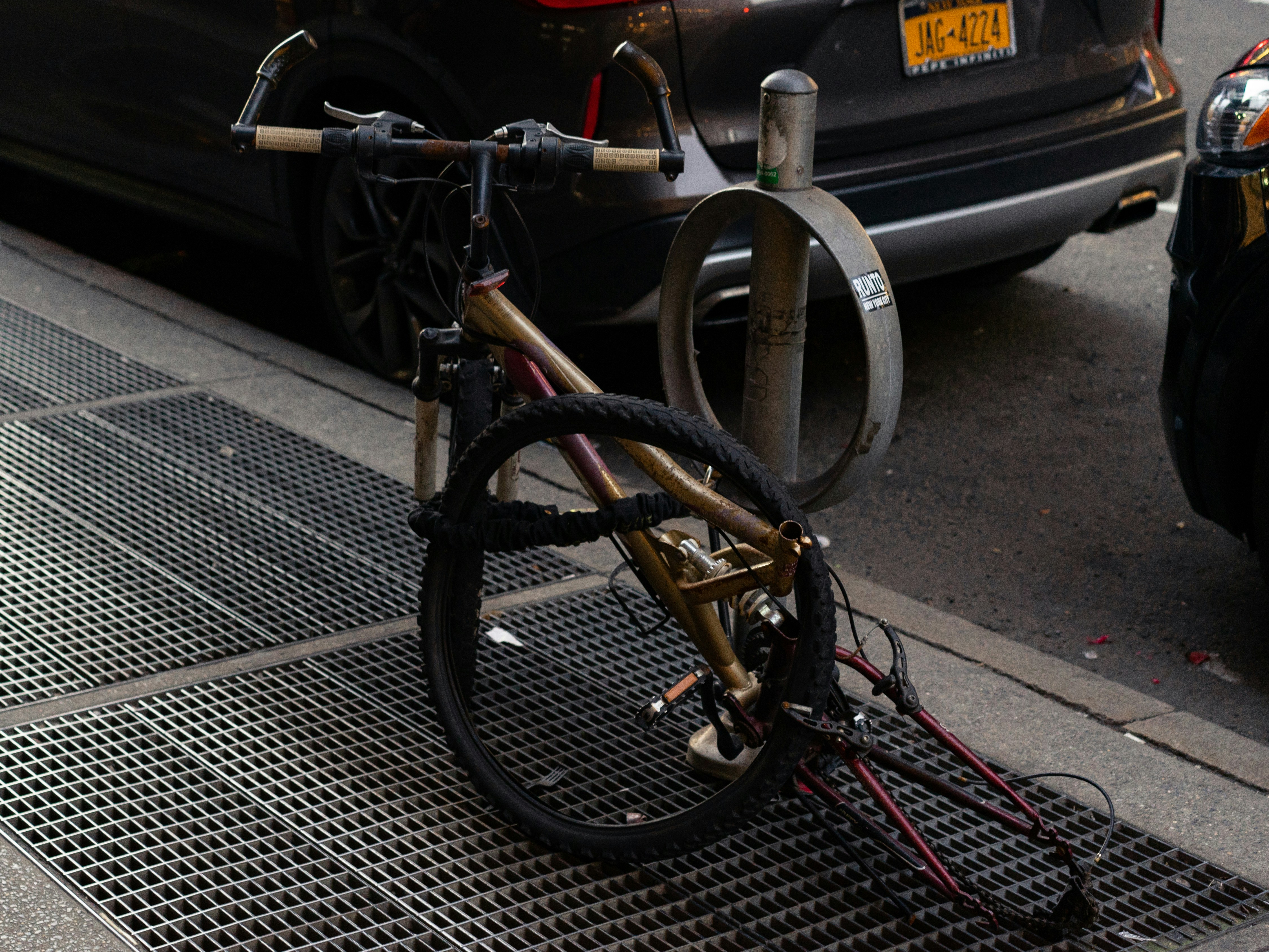 Urban Lockup: Bronze-Frame Bicycle Locked to a Looping City Rack