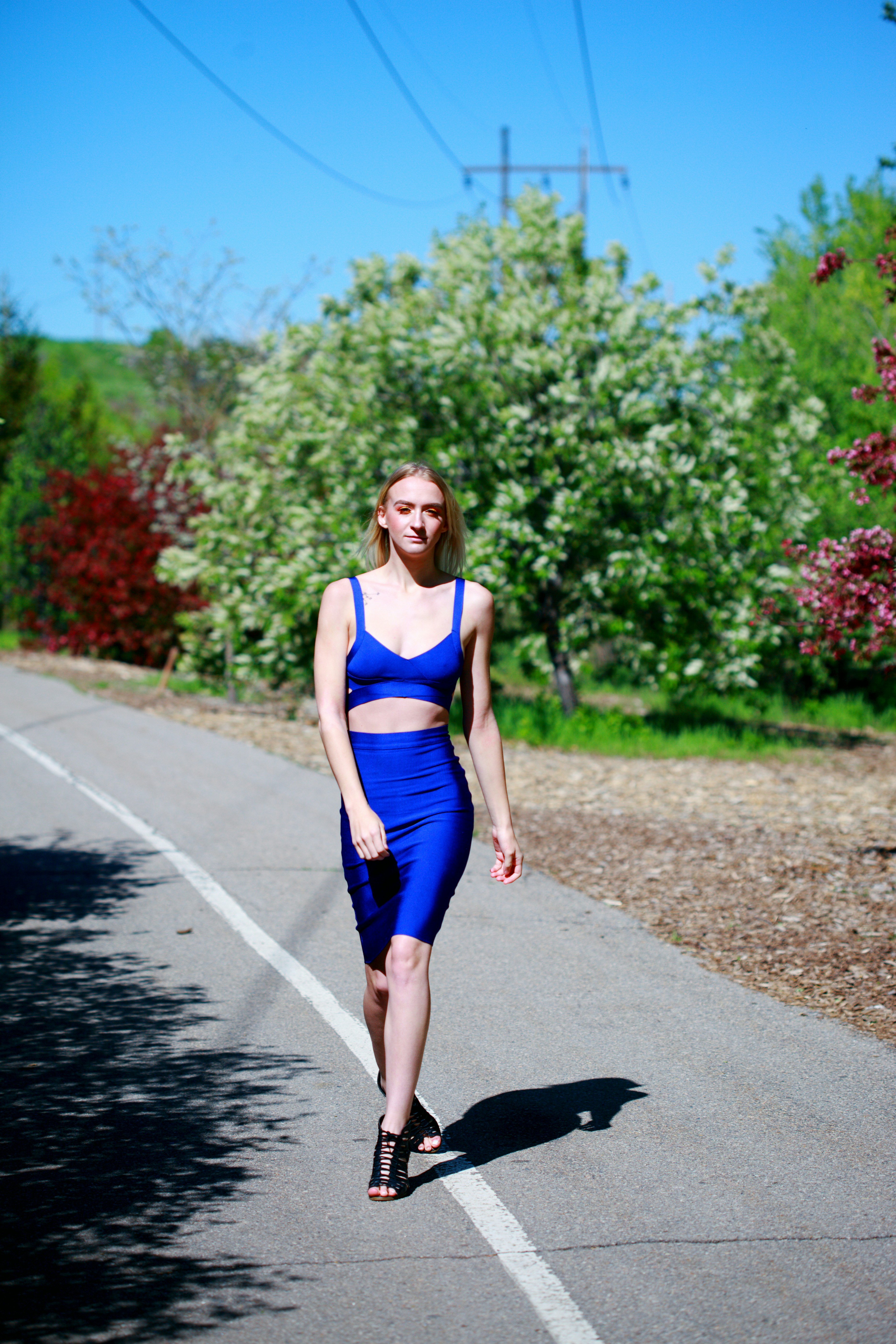 A nineteen year old young woman in a blue dress