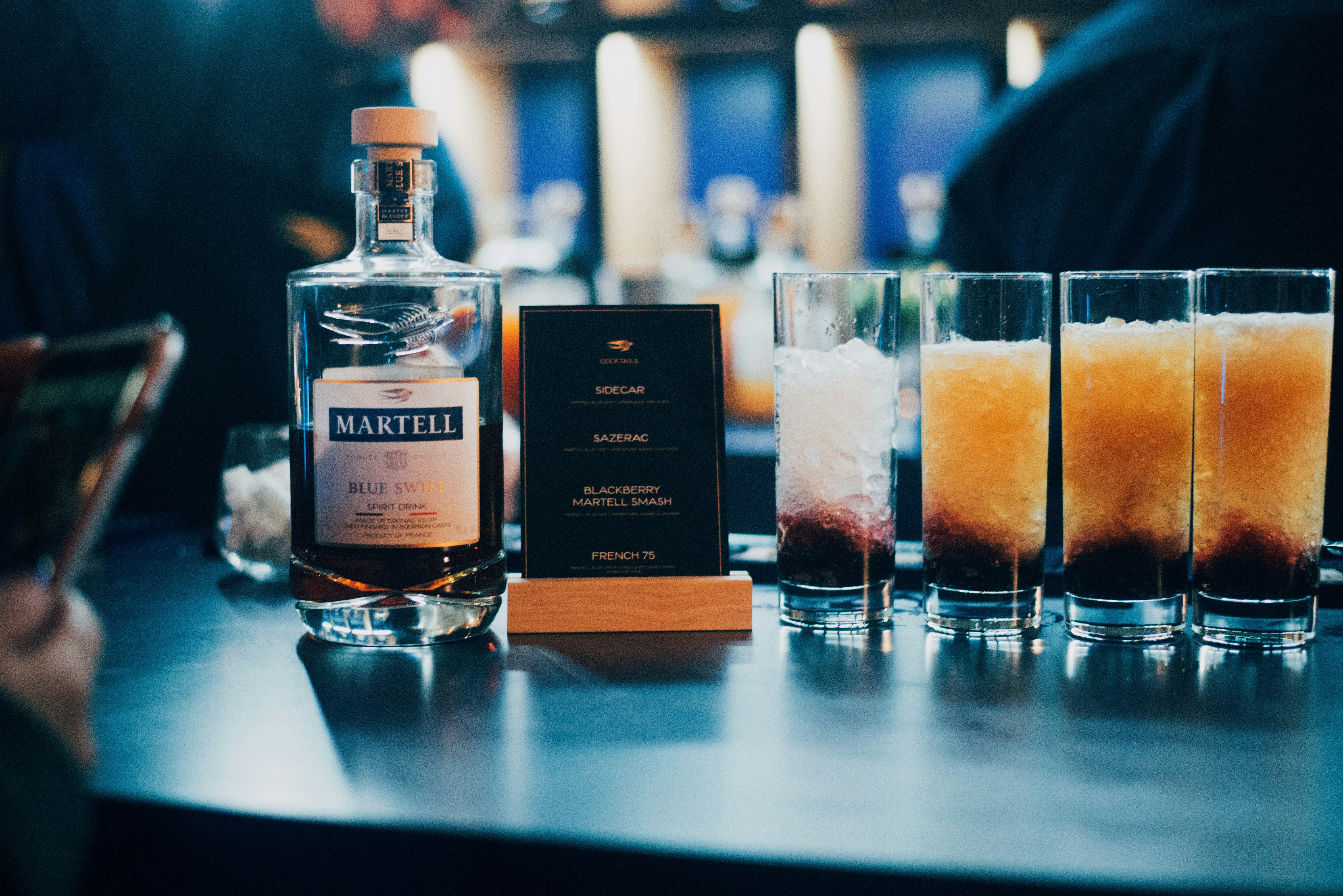 Amber Hour at the Bar: Martell, Glasses, and Blue Glow