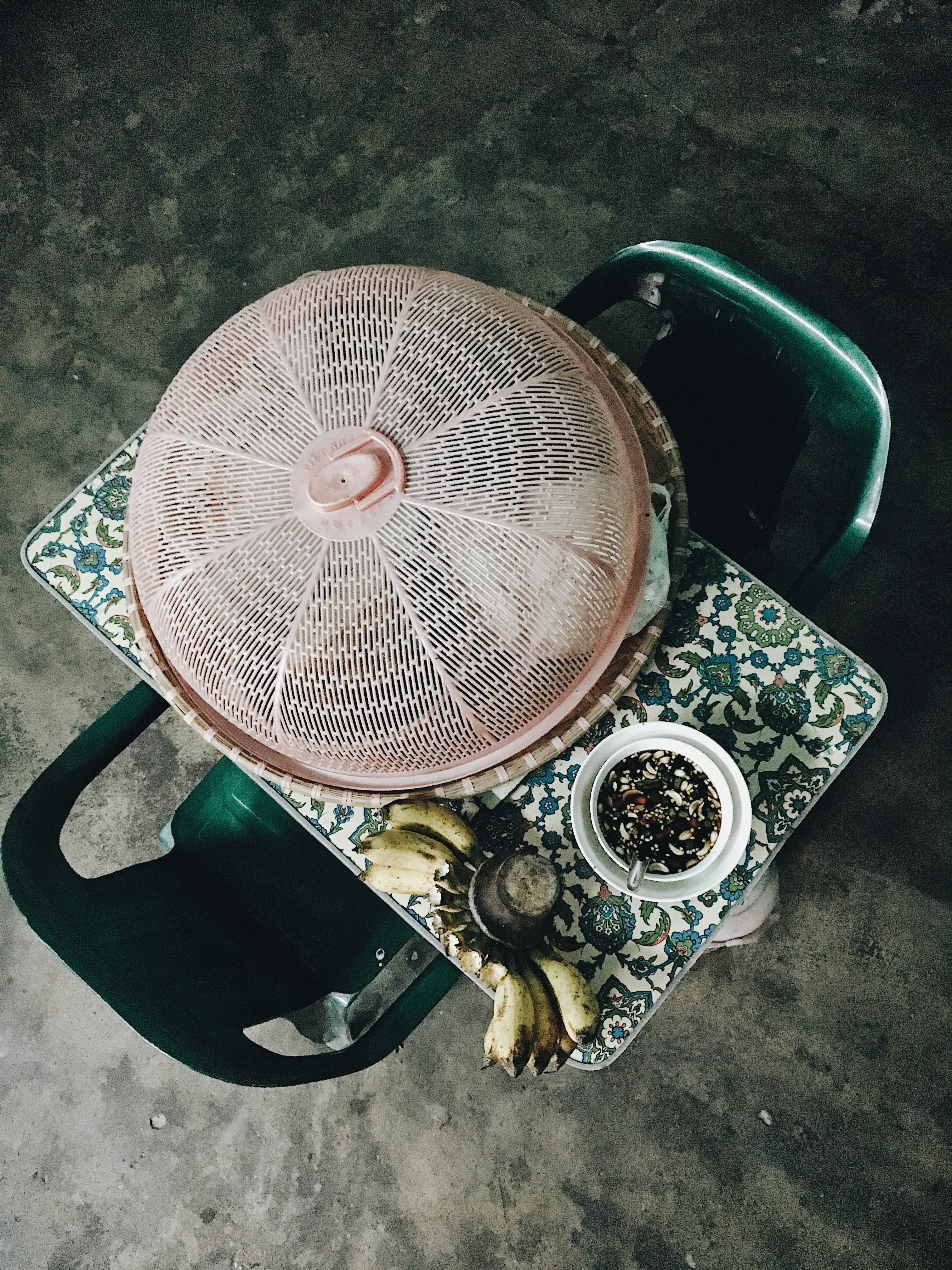 Pink Mesh Dome on a Floral Table: A Quiet Kitchen Still Life