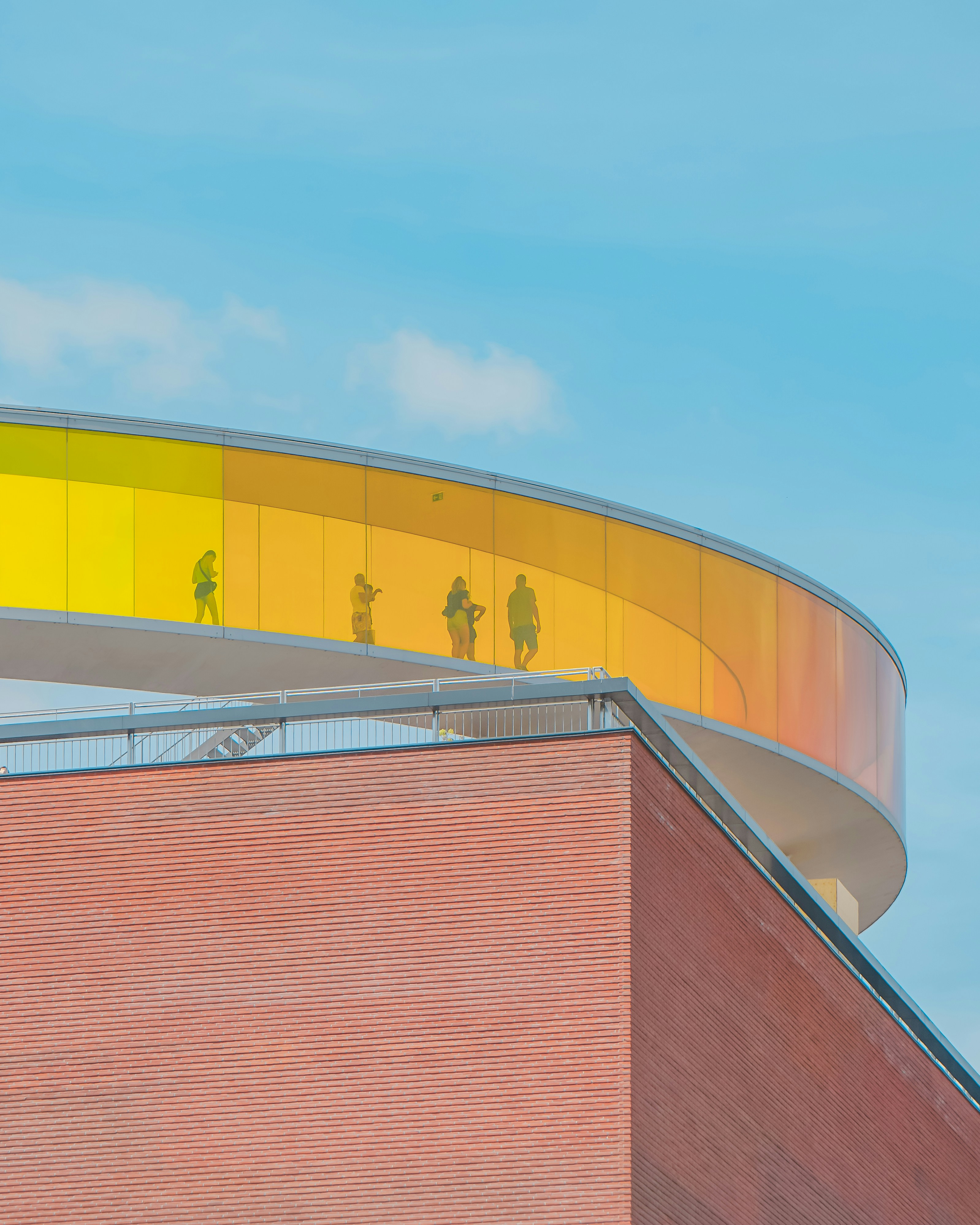 Curved Glass Atrium at Dusk: A Strip of Amber Over Brick