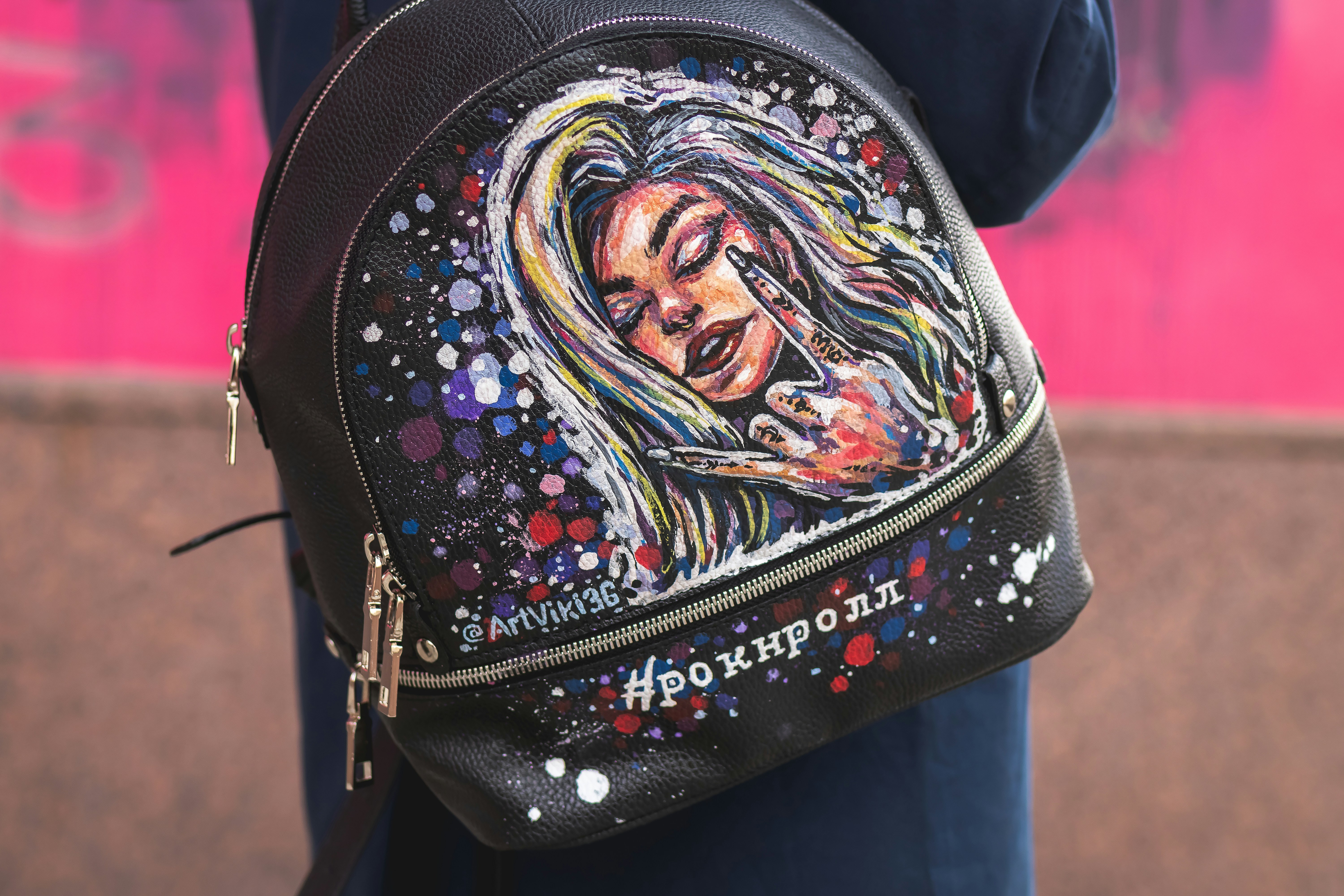 Portrait on a Backpack: Neon Splash Against a Pink Urban Wall