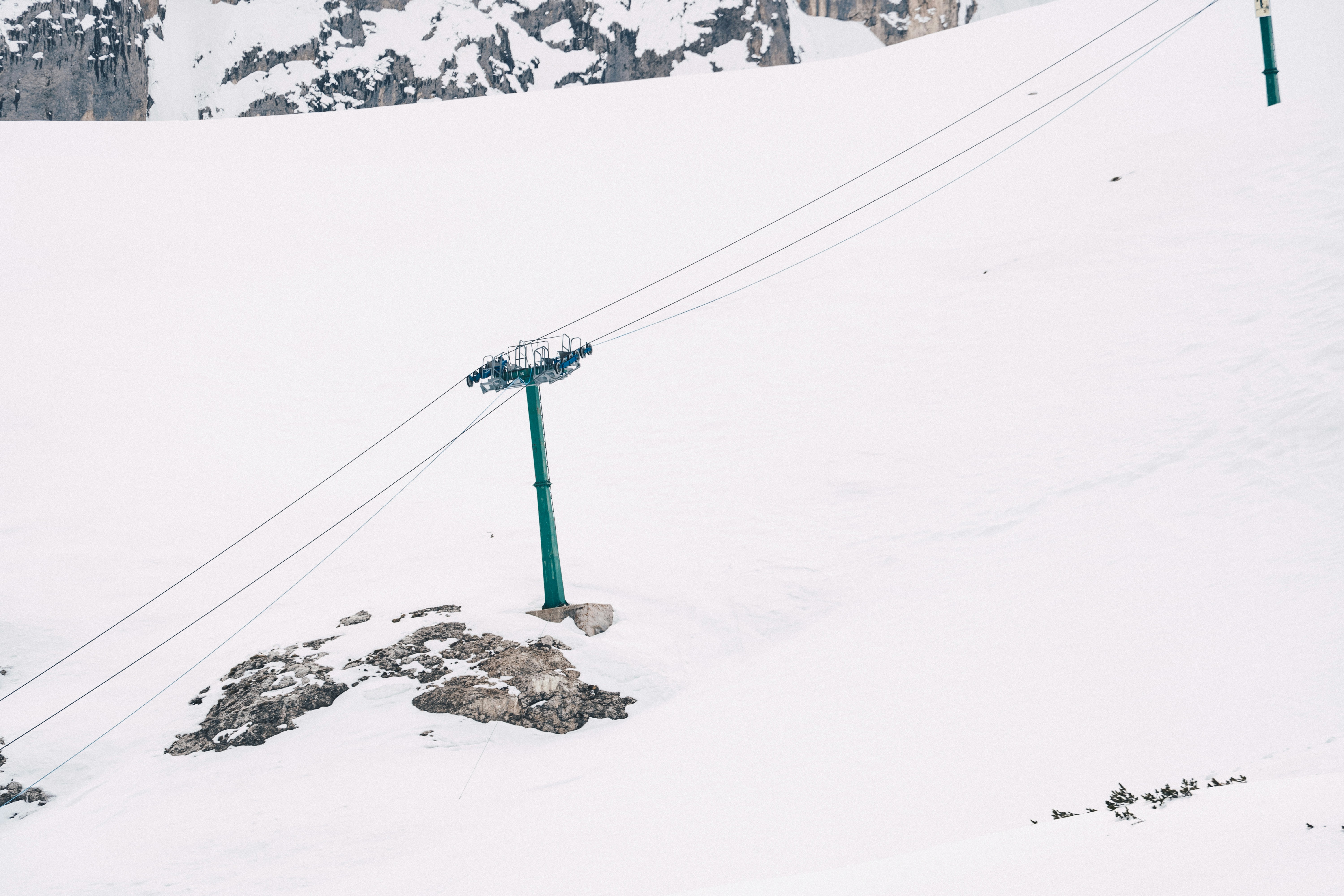 Green Ski-Lift Pole Traces a Silenced Alpine Slope