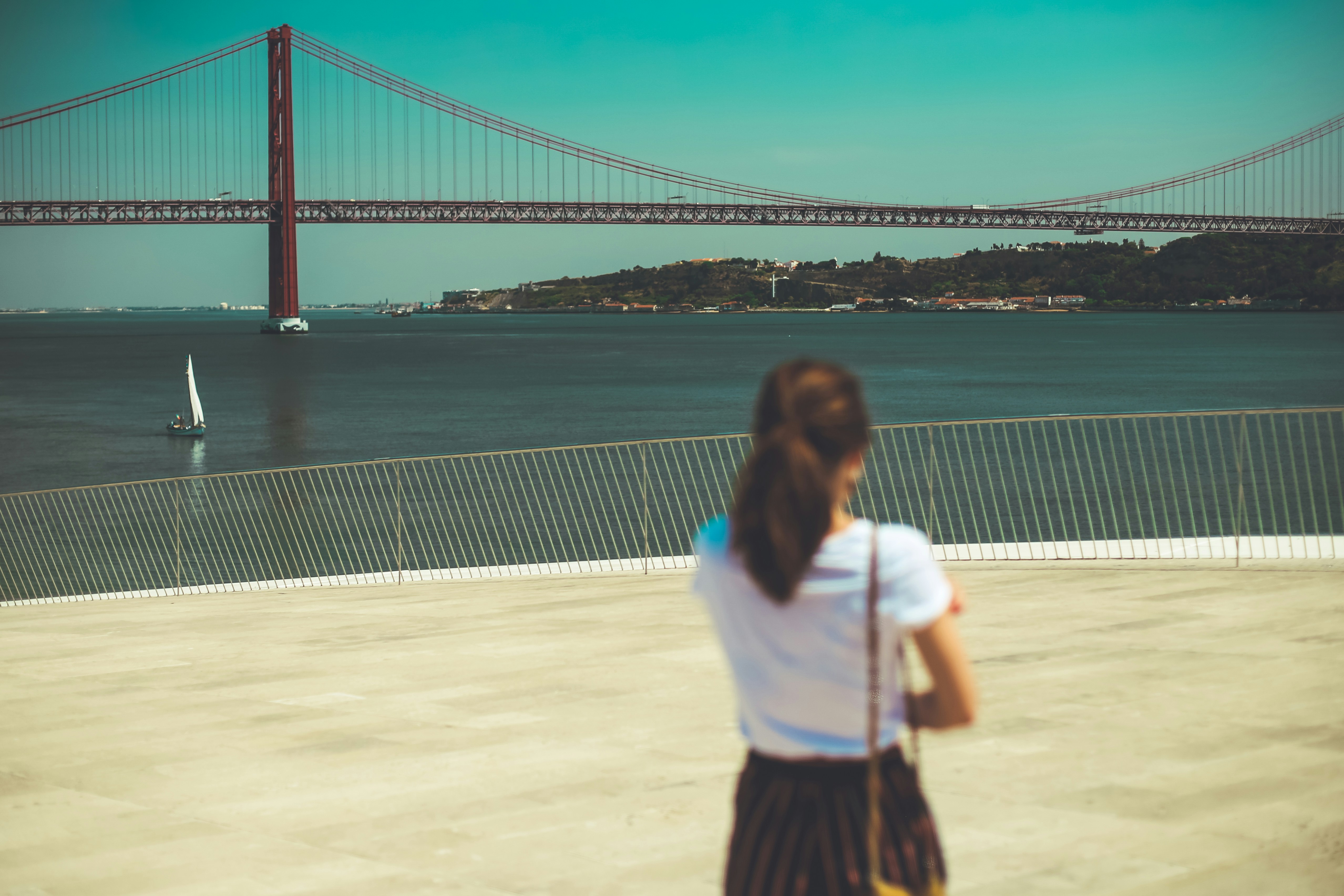 A Quiet Overlook: Portrait of a Visitor Gazing Toward the Bridge