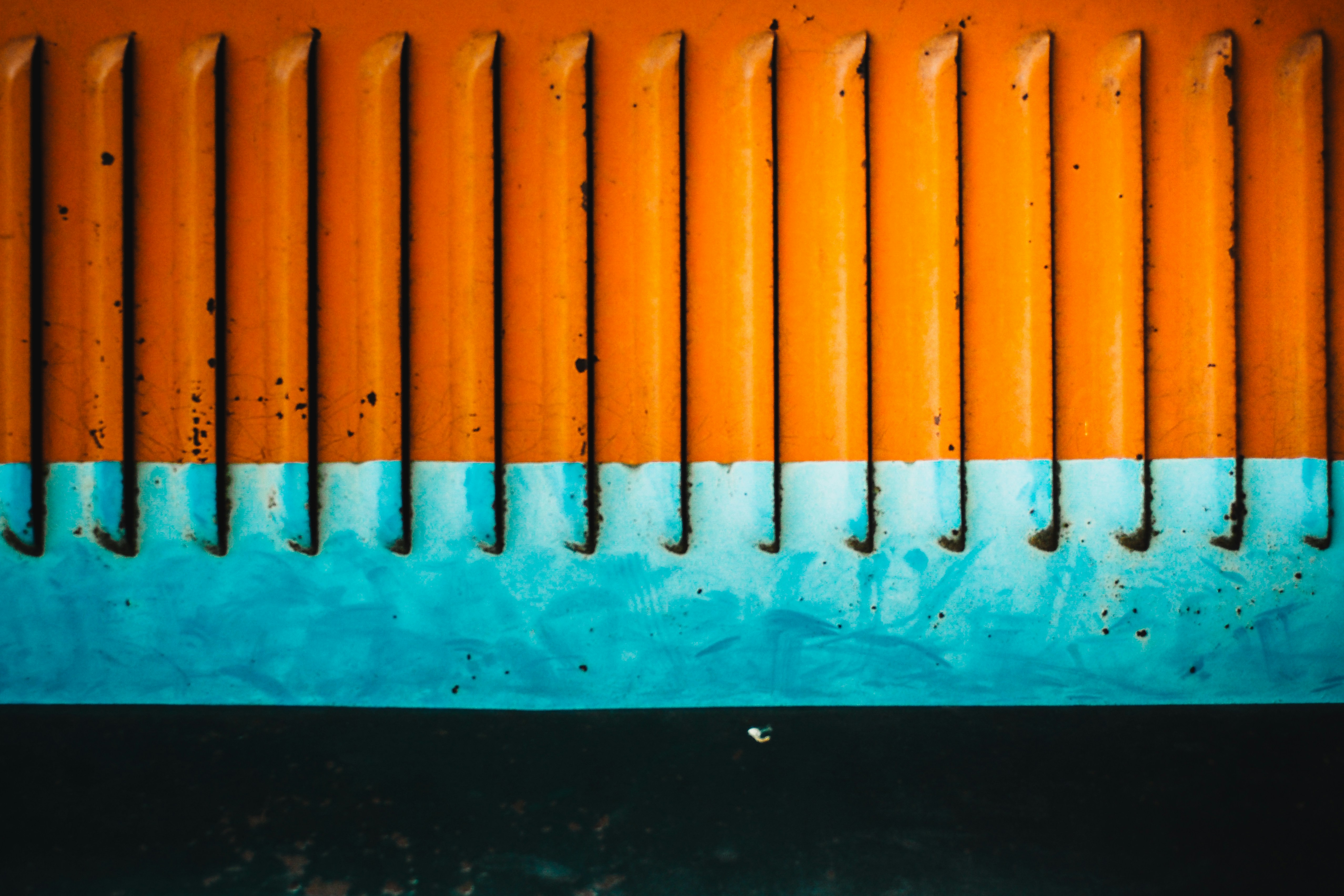 Industrial Rhythm: Orange Ridges Meet Cyan Spill