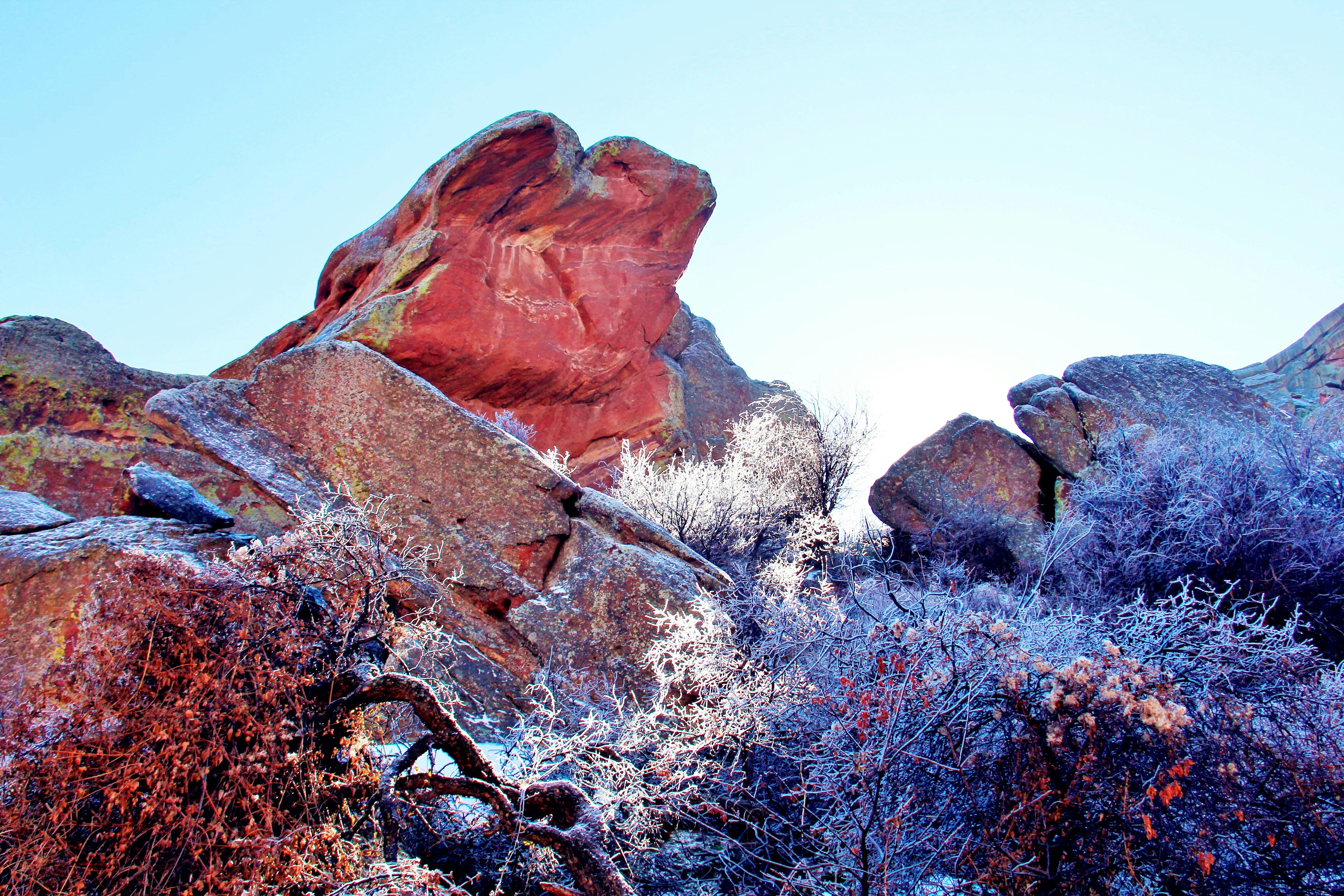 Crimson Monolith Crowned by Frosted Pines