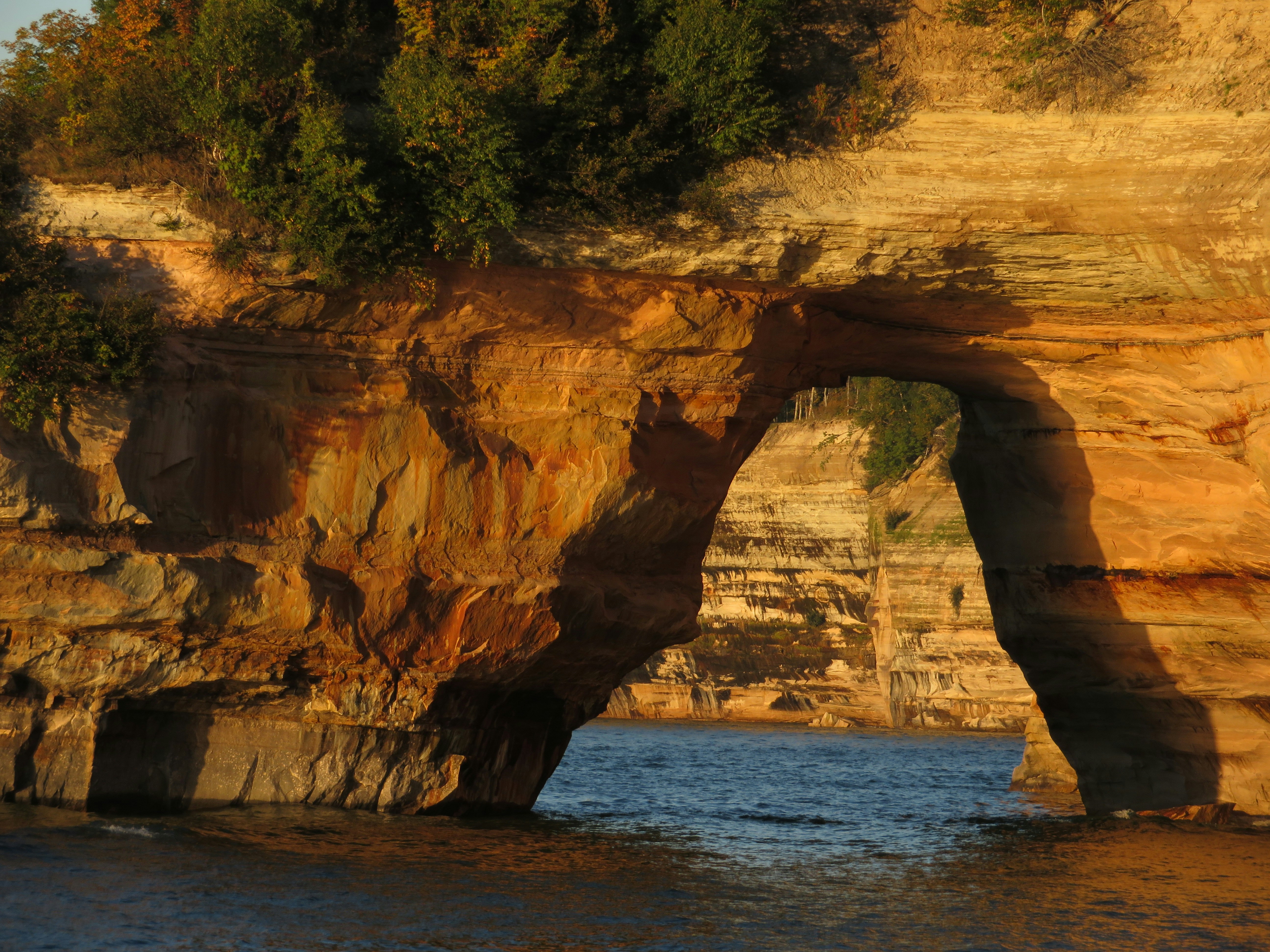 Painted Rocks on the southern side of Lake Superior. | brown land formation on sea