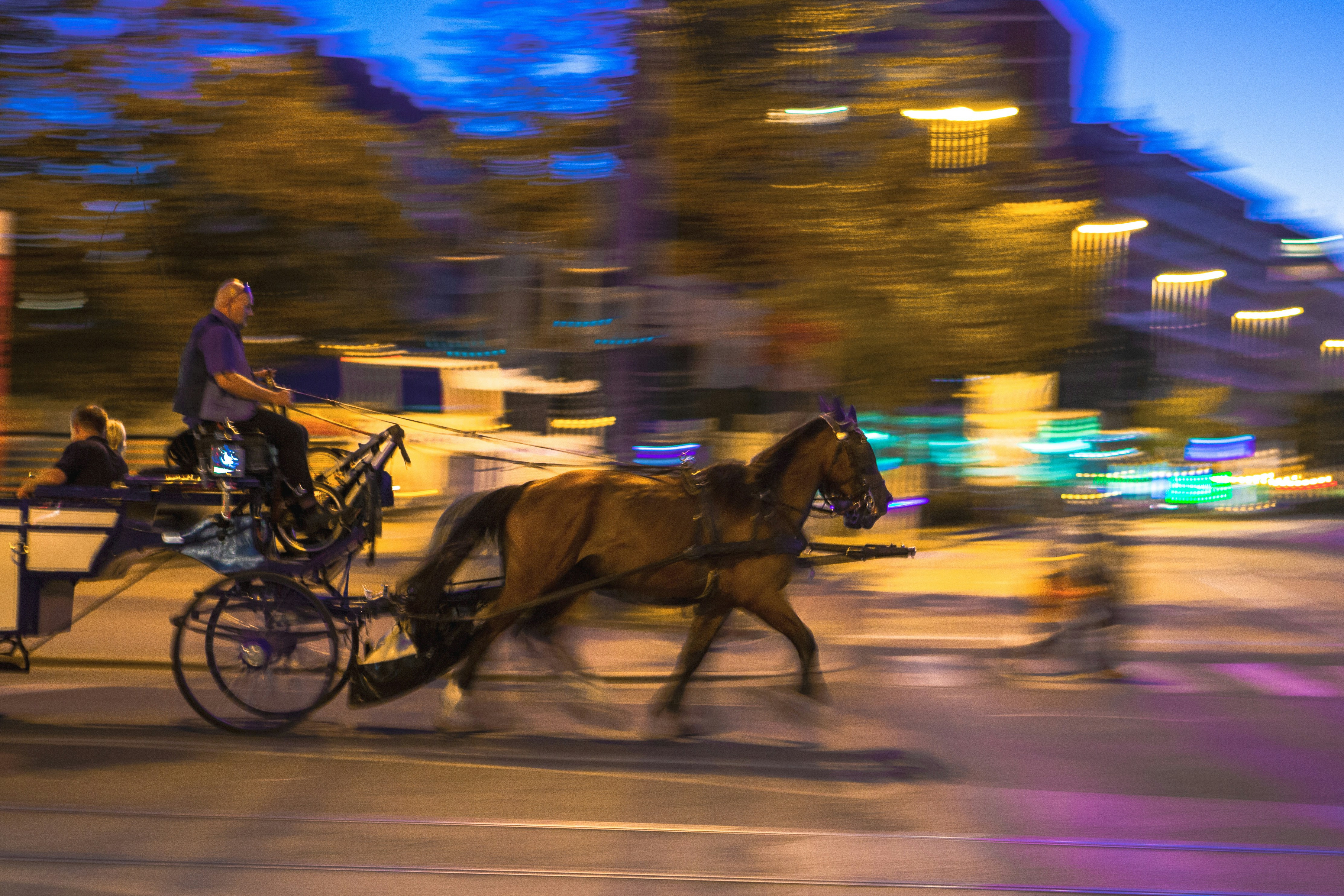 Night Dash Through Neon: A Horse-Drawn Carriage in Motion