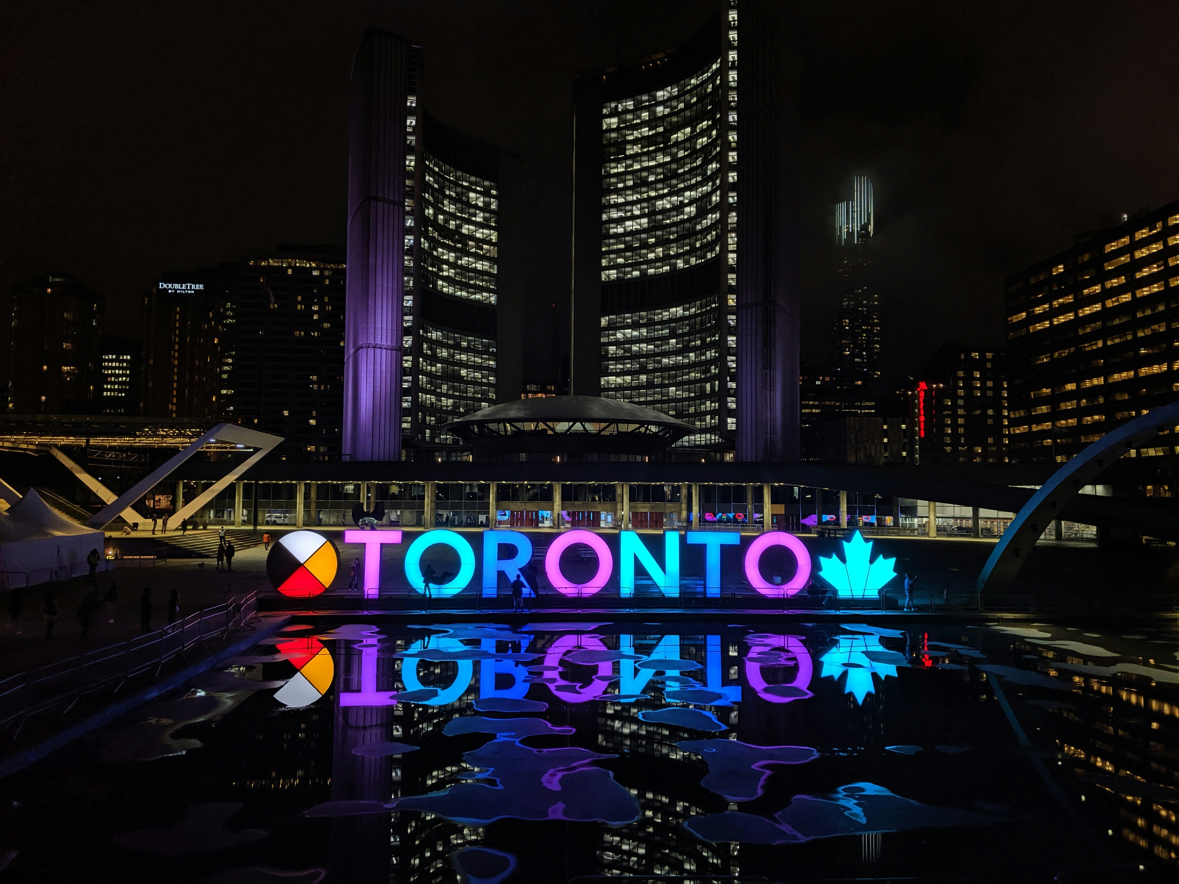 Neon Toronto Reflections: Night Signage Over Quiet Water
