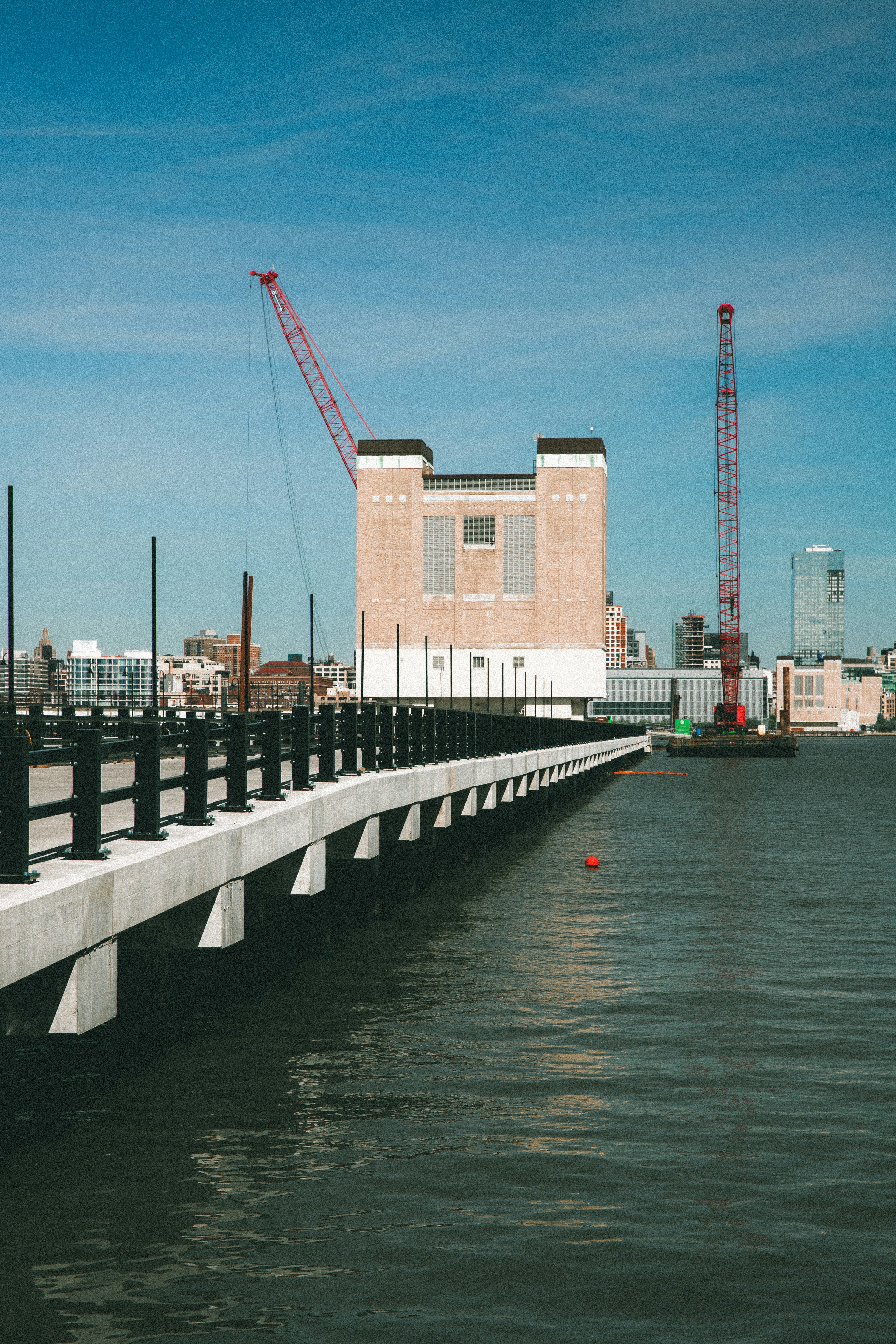 Harbor Crane Ballet: Brick Warehouse Framed by Water and Sky
