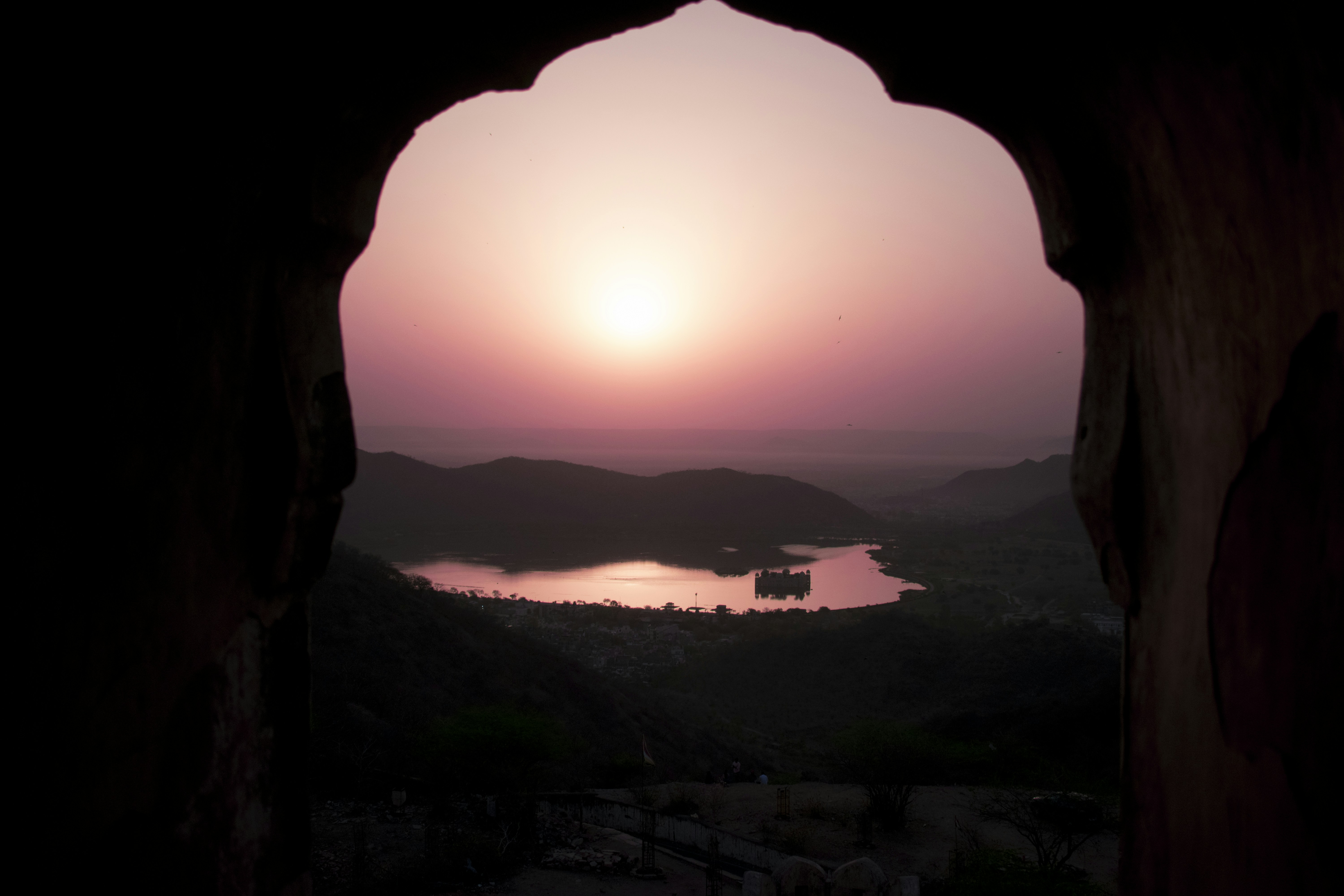Cave Window at Dusk: A Lake Lit by Sunset