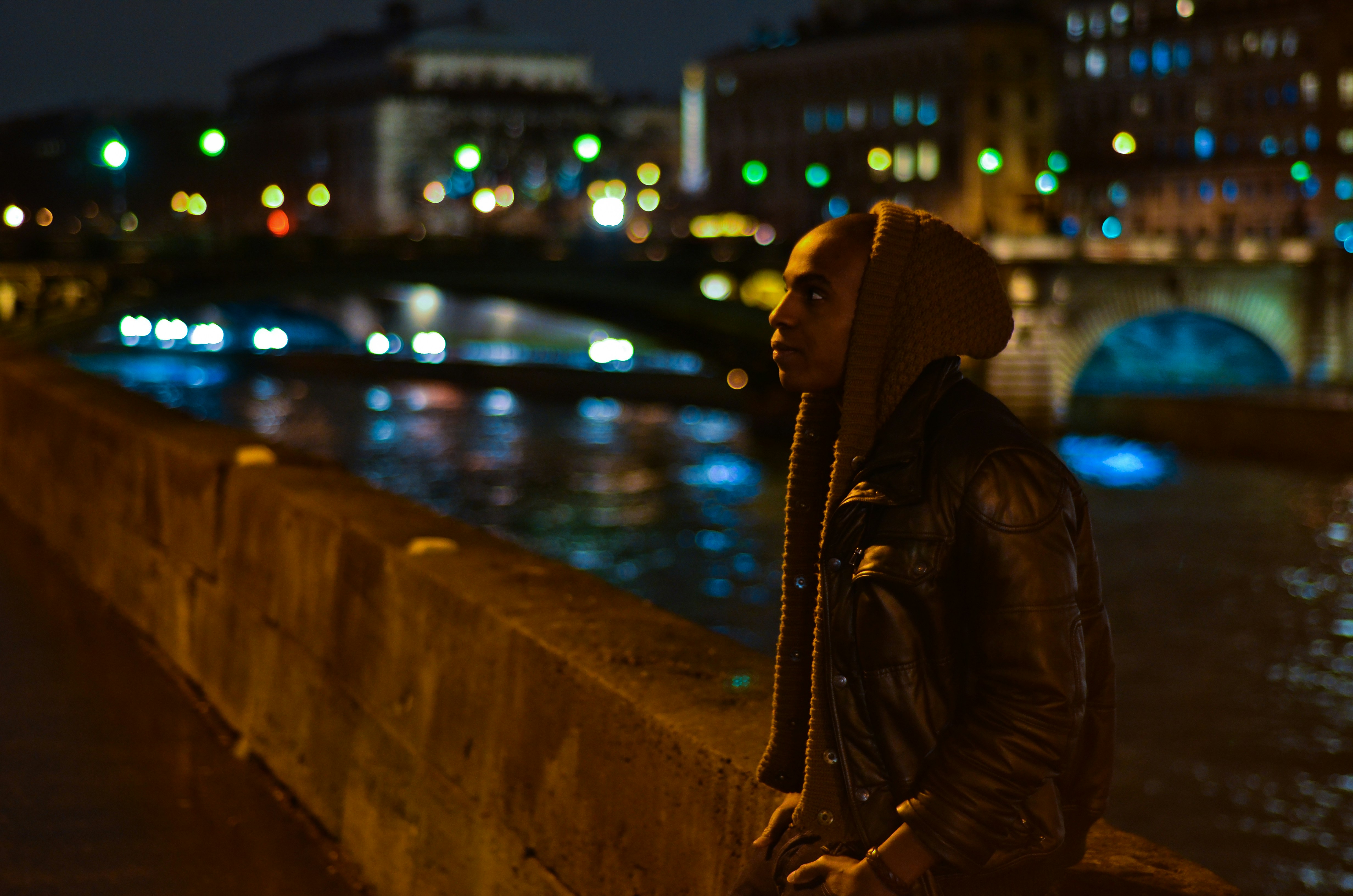 Amber Riverside Portrait: Hooded Figure by the Water's Edge