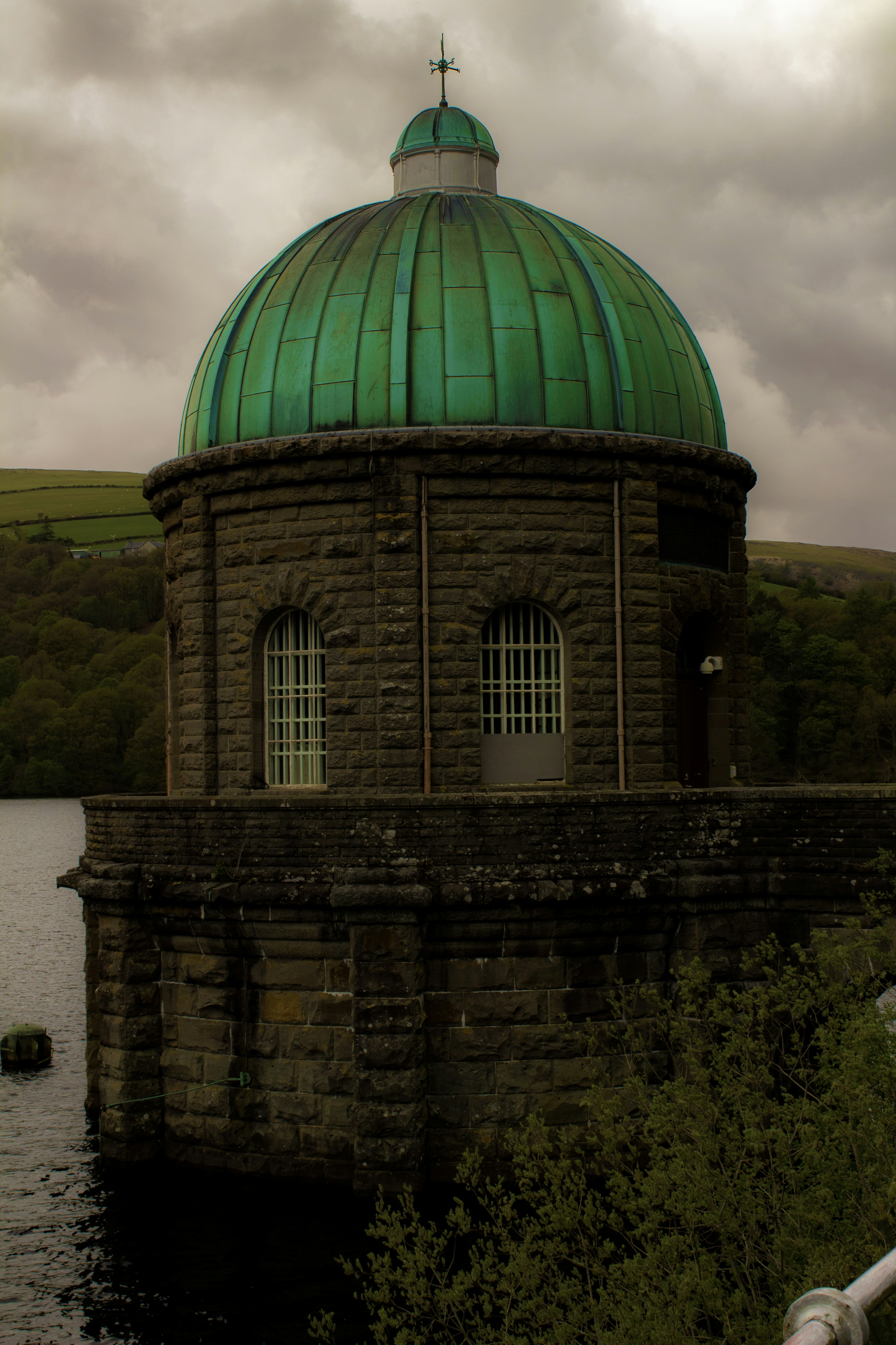 Green Dome Over Stone Turret on Quiet Lake