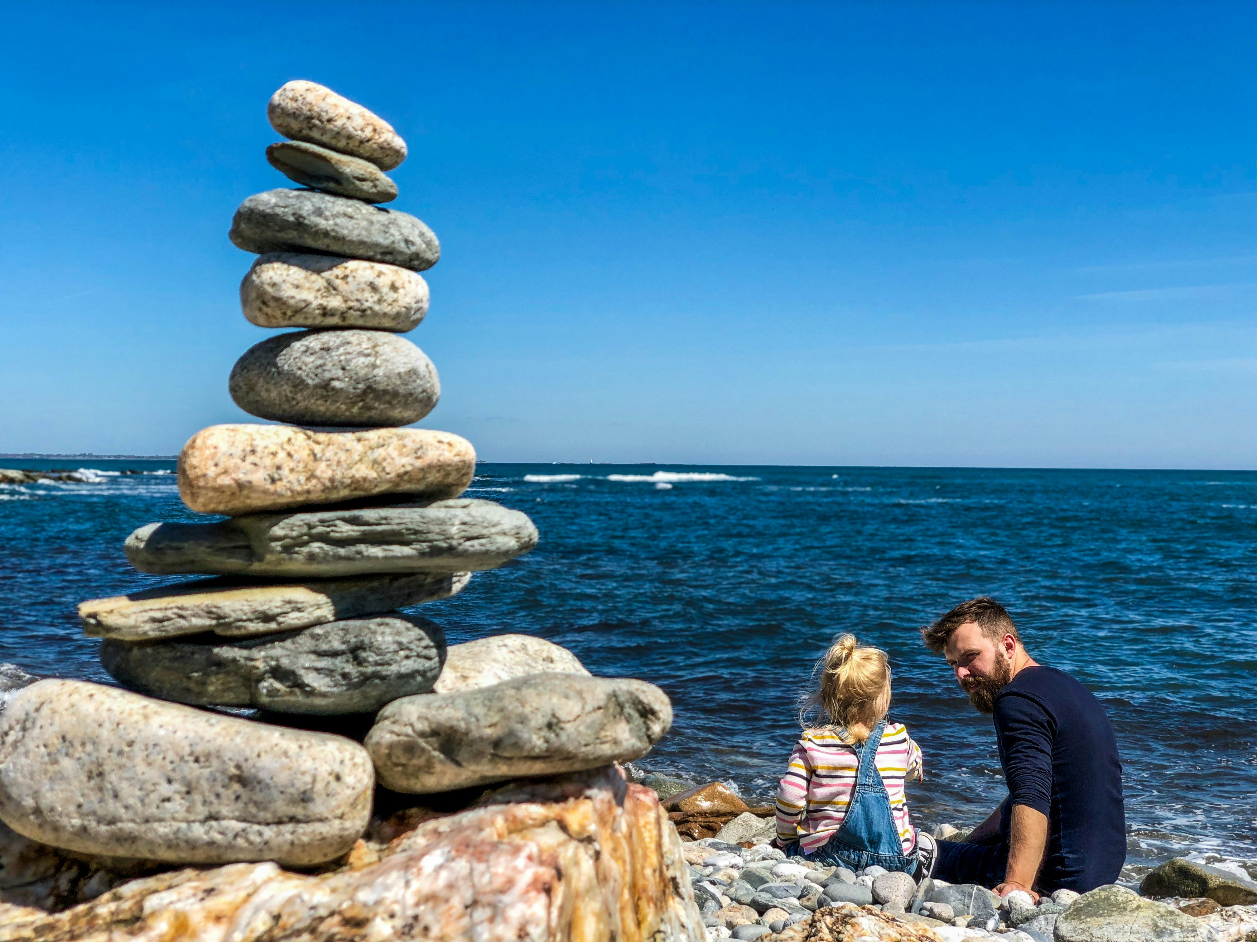 Seaside Harmony: Balancing Stones and Shared Moments