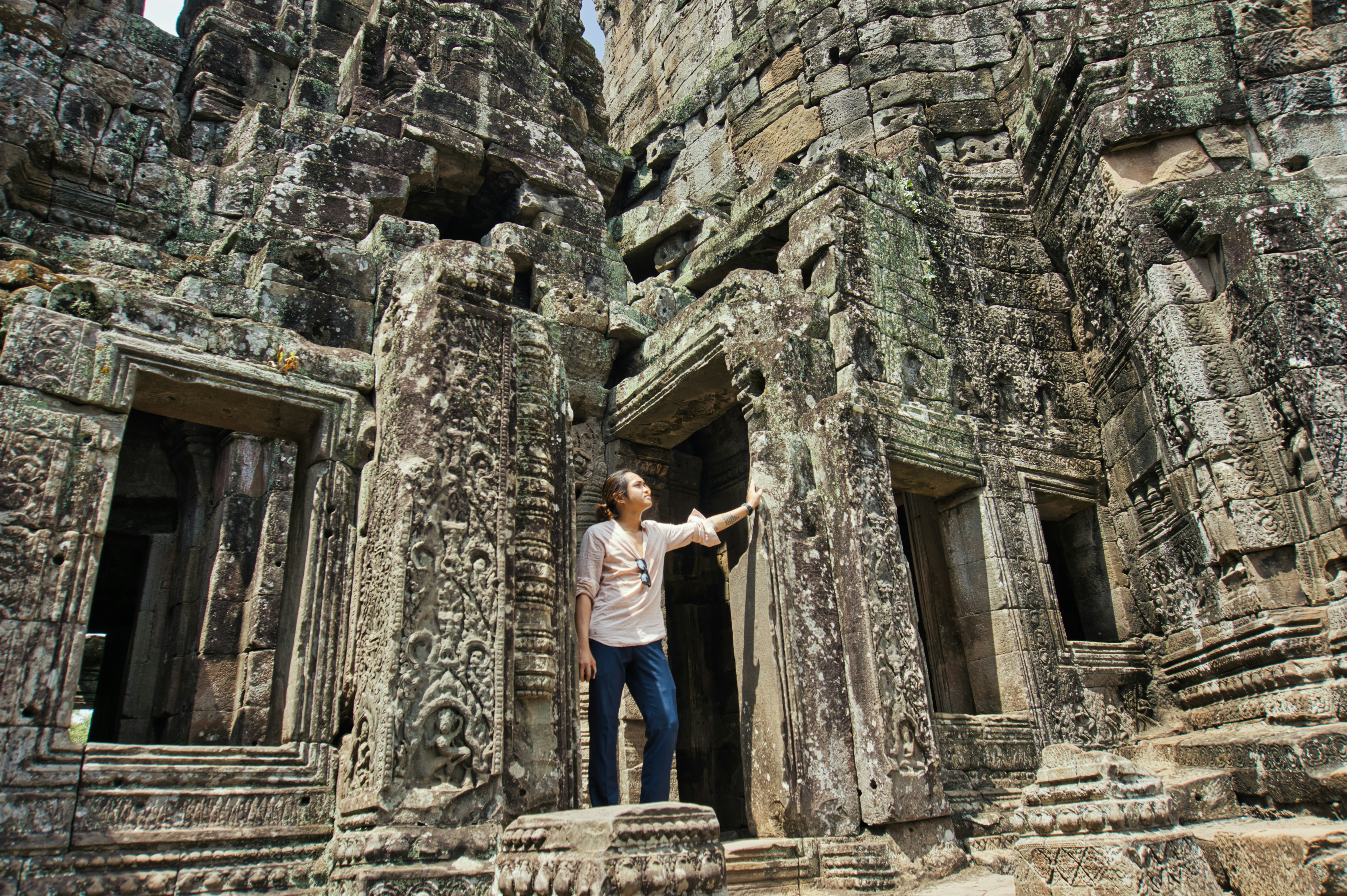 Explorer in the Carved Ruins: A Quiet Moment Amid Stone Carvings