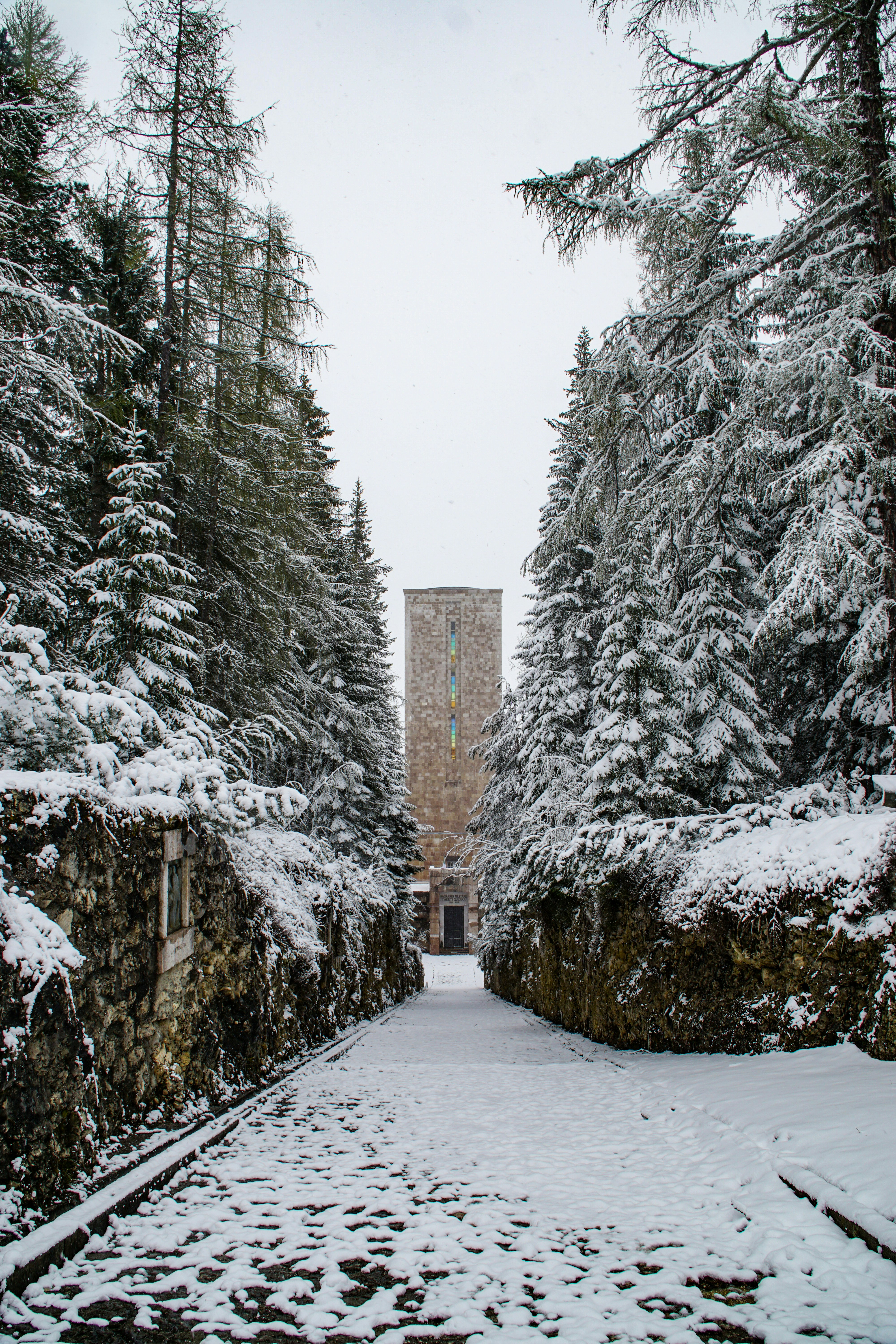 Snow-Lined Corridor Toward a Distant Stone Tower