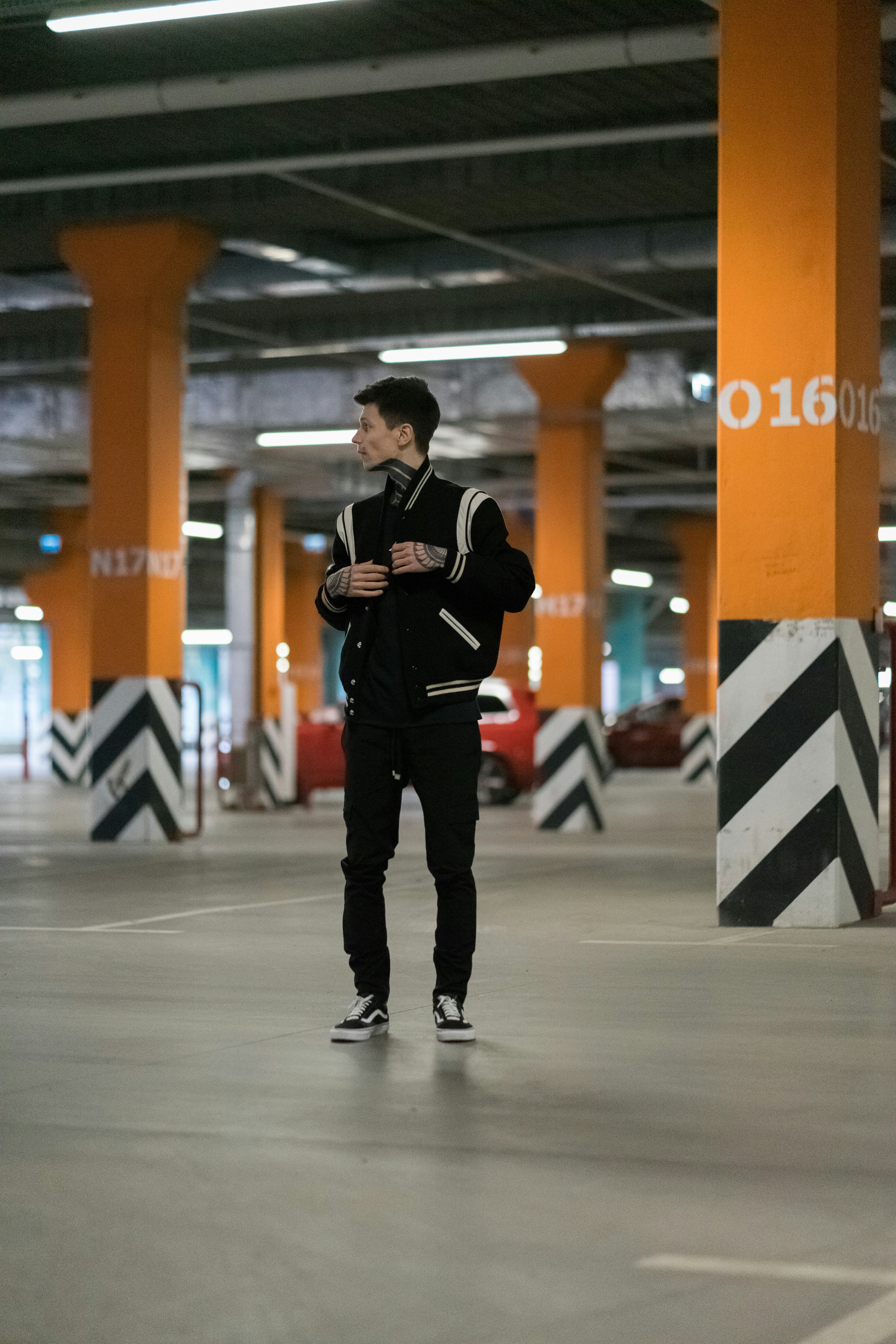 Man standing under building's basement parking area photo – Free Shoe ...