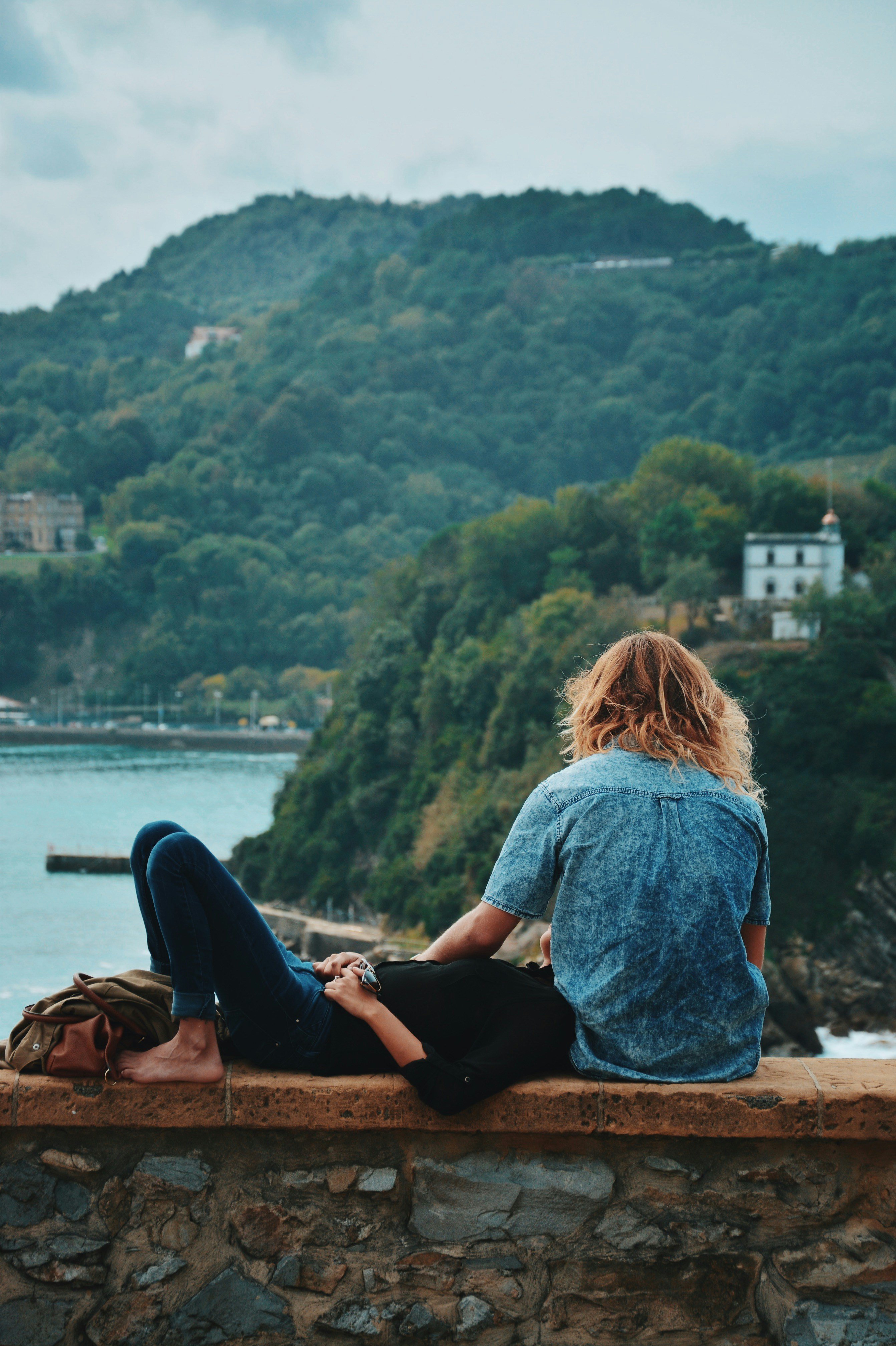 Two person sitting on brown concrete bench outdoor during daytime photo ...