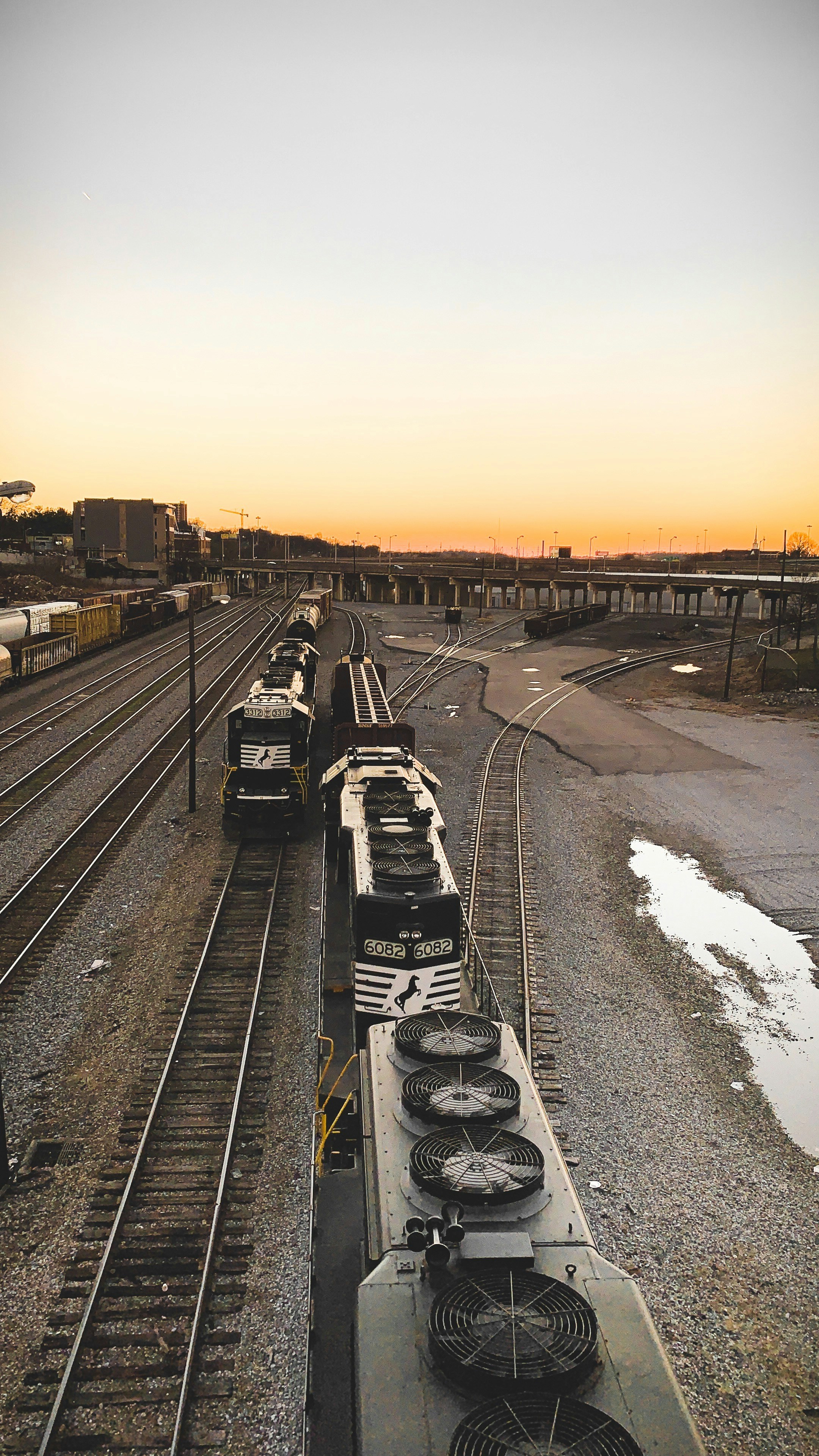 Dusk Convergence: Trains Stretch Along a Quiet Rail Yard