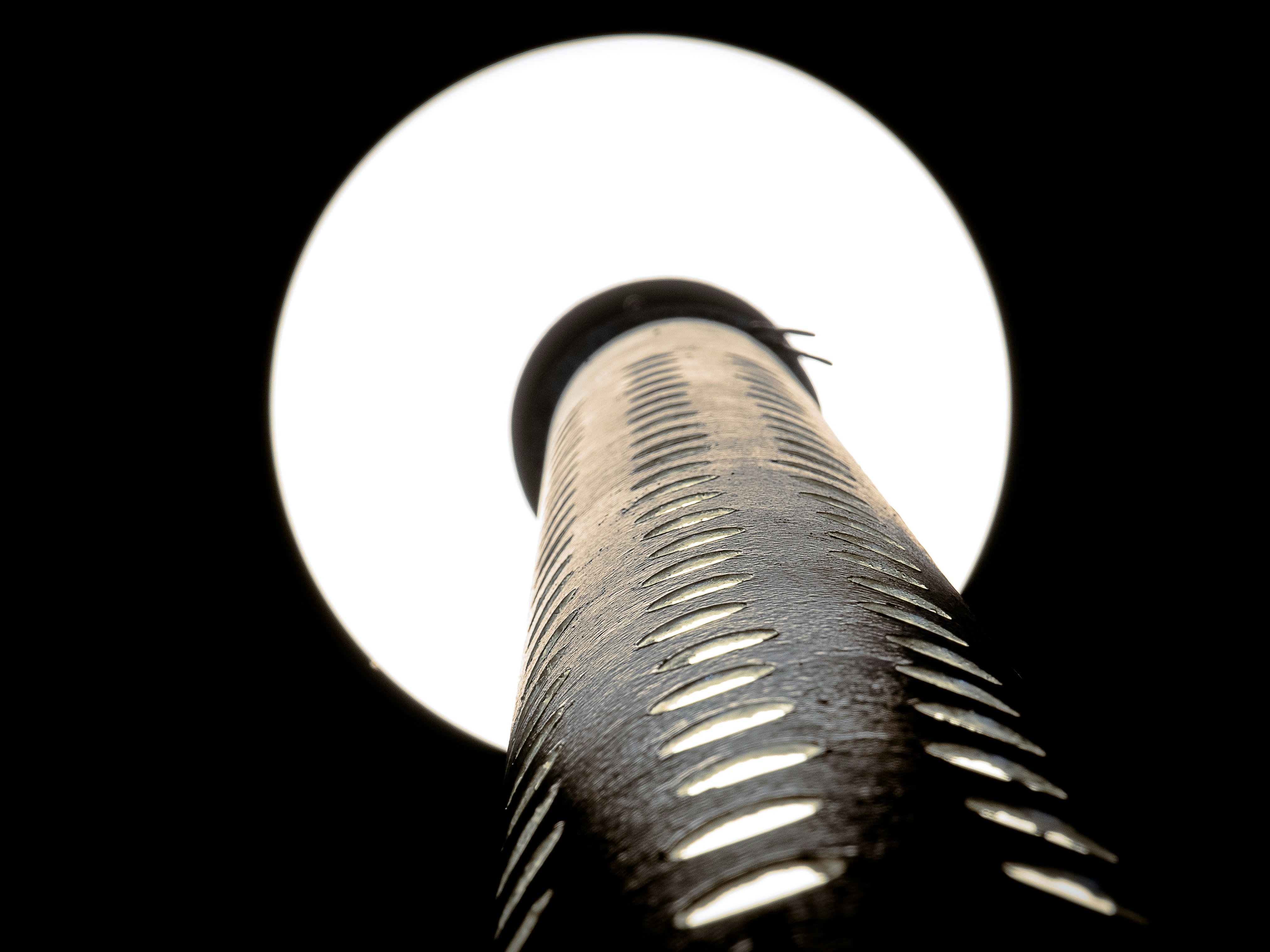 Halo Above the Ribbed Pole: Night-time Streetlight Close-up