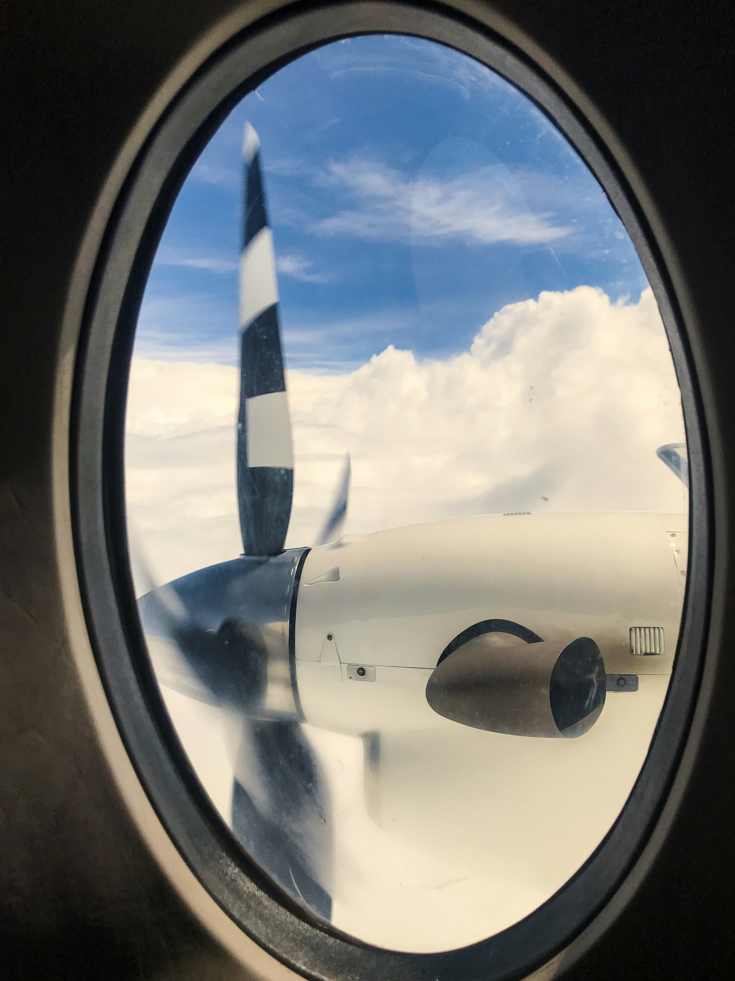 Stripe of the Propeller Against a Cloudscape: Window-Seat View