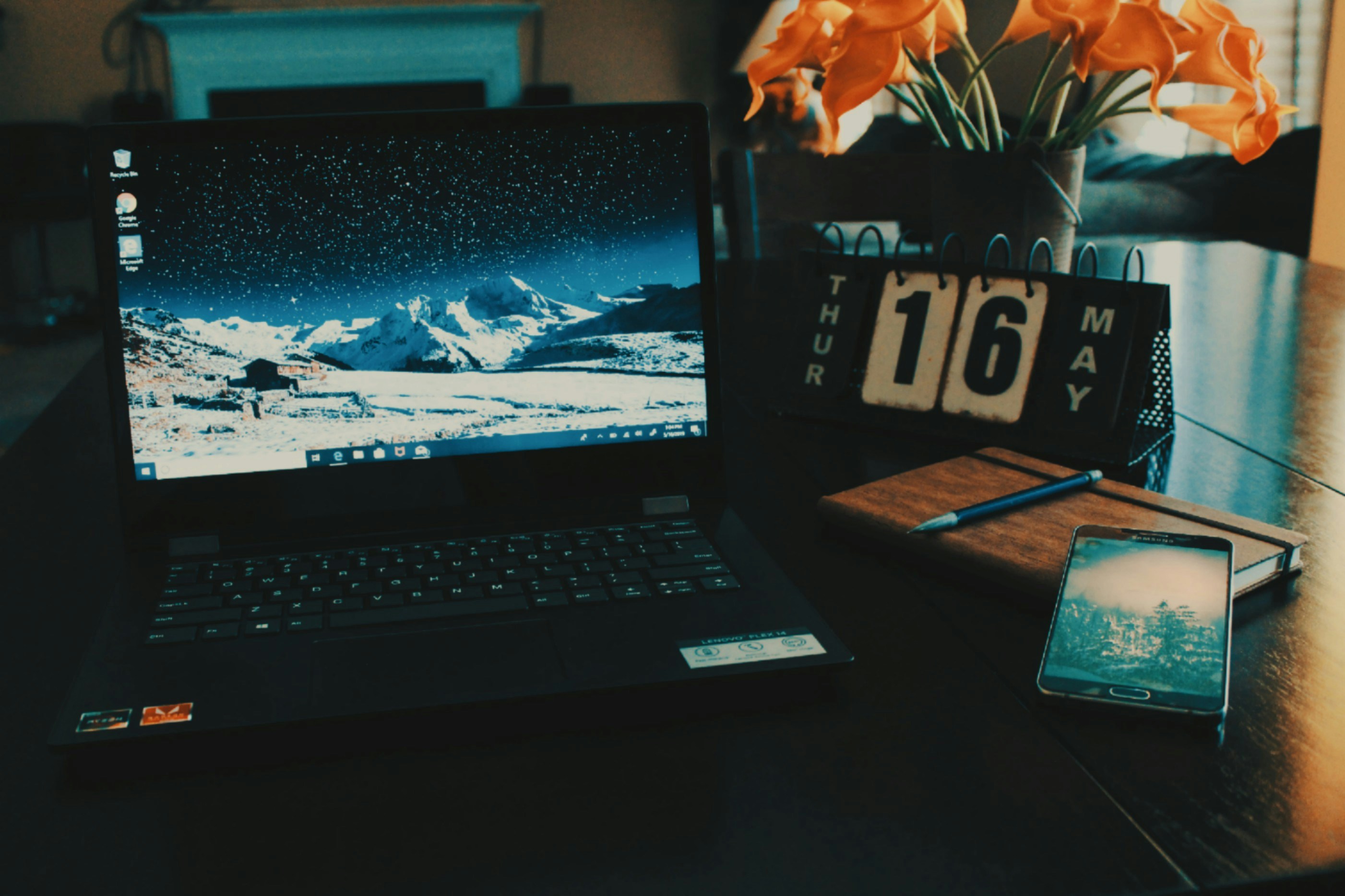 Black laptop computer turned on on table beside phone photo – Free ...