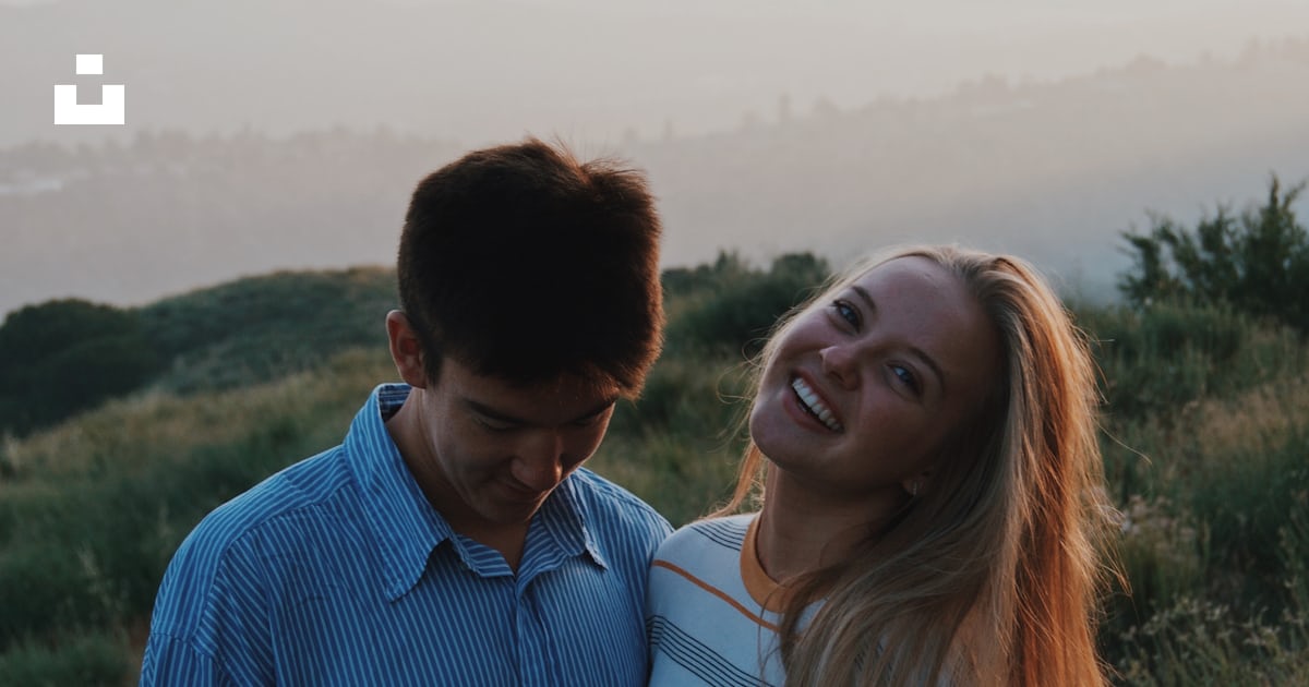 Man Wearing Blue Dress Shirt And Woman Wearing White And Gray Stripe
