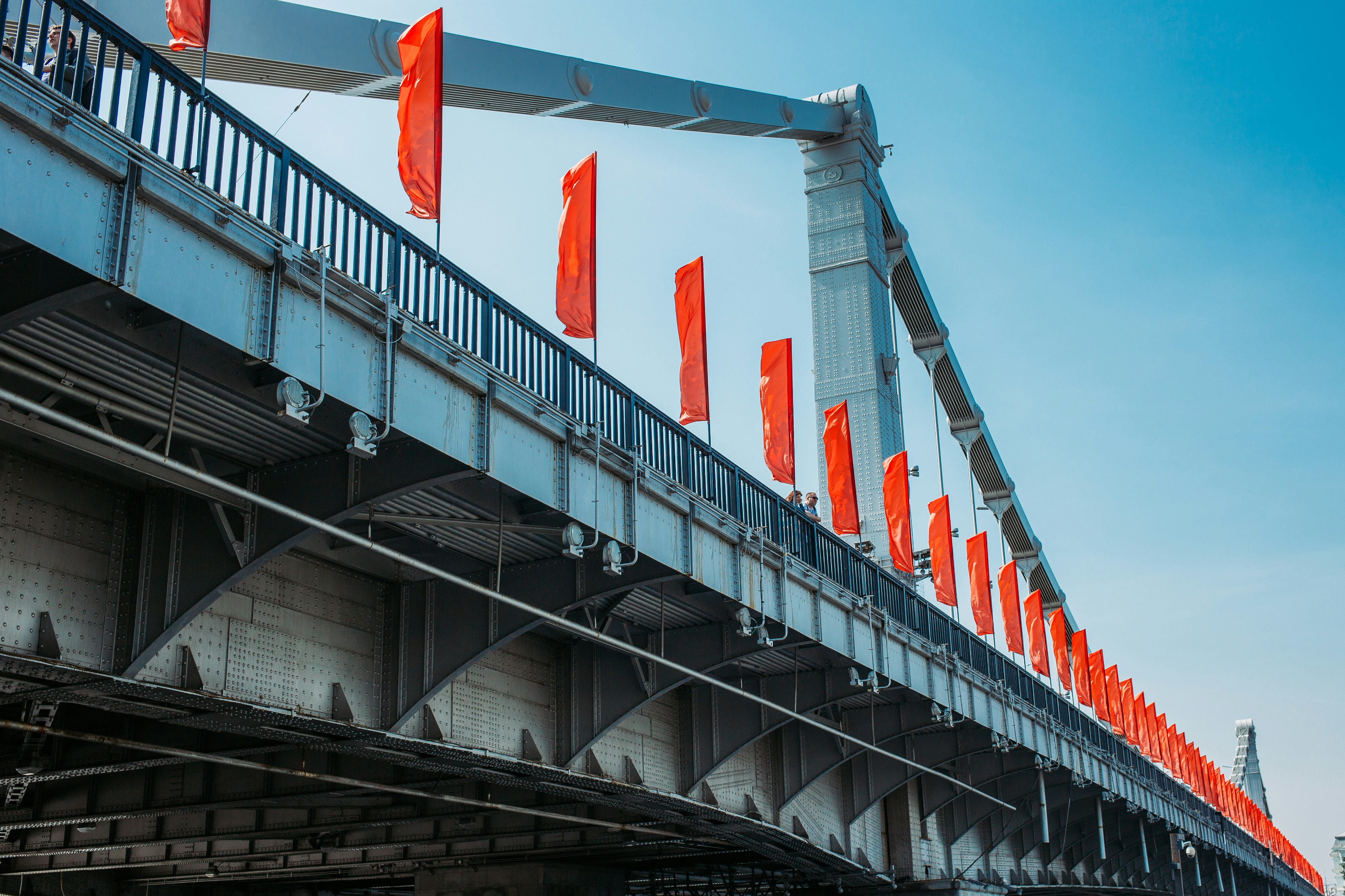 Rising Red Streams: Flags Along the Bridge