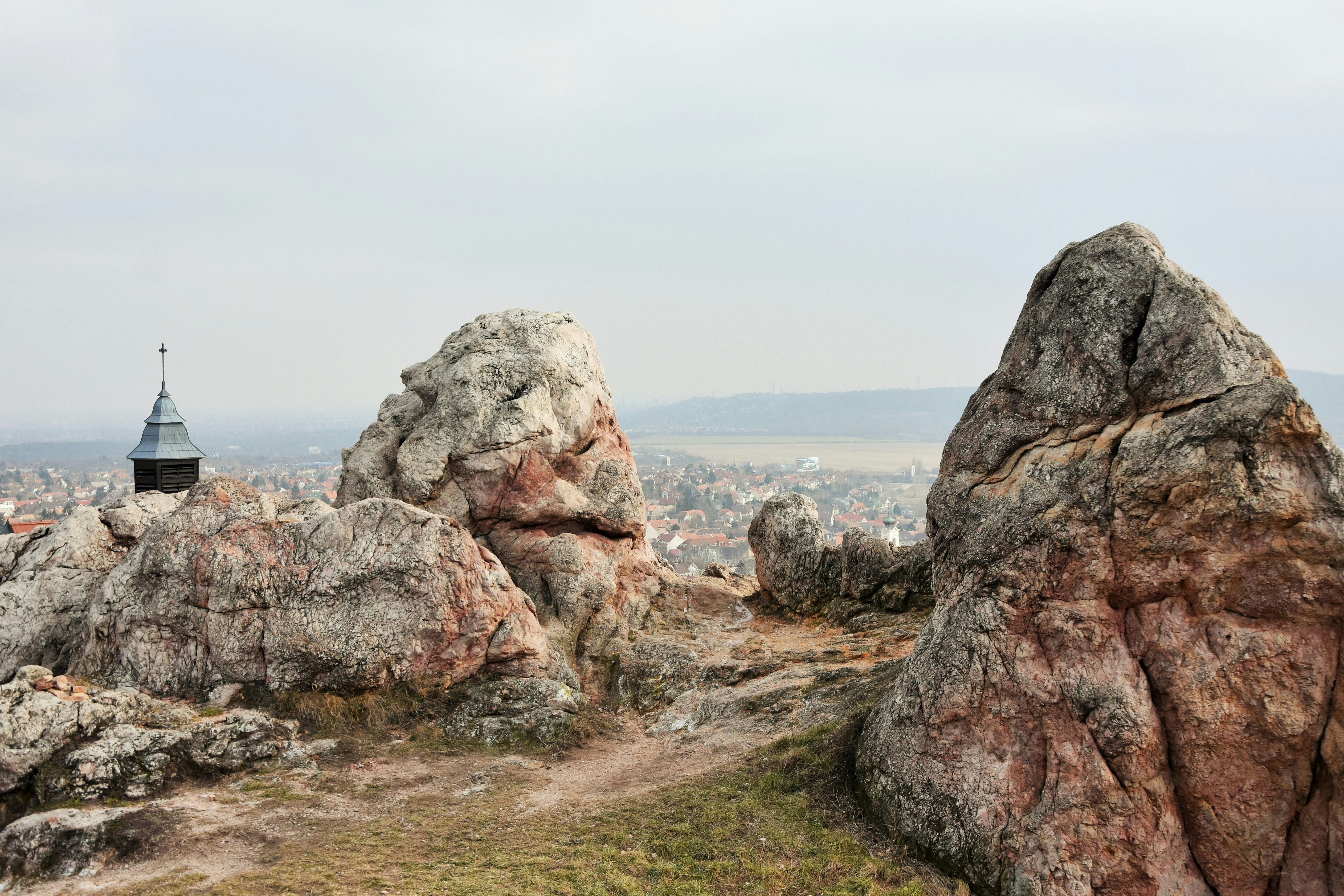 Stone sentinels overlook a distant village from the hilltop