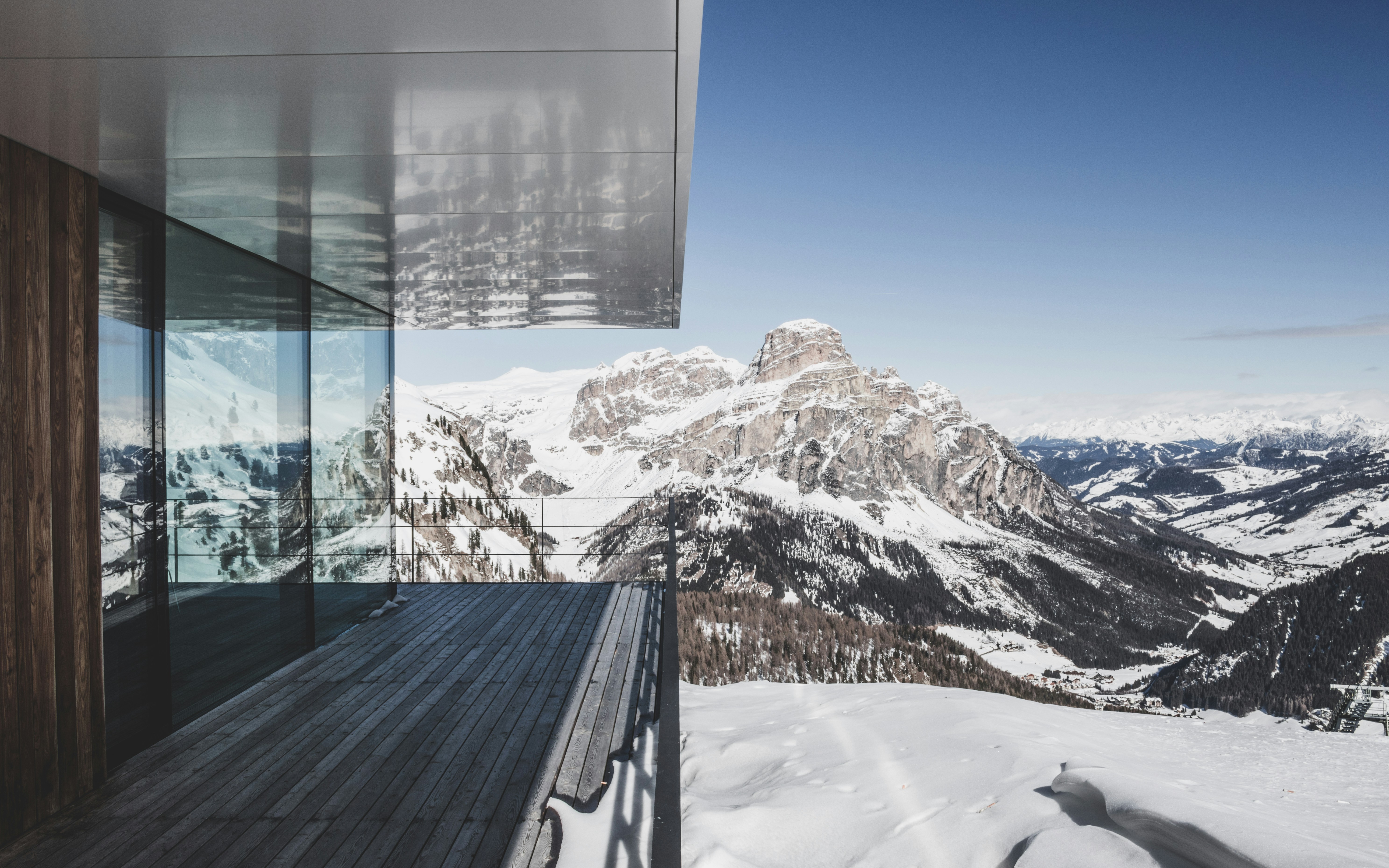 Glass-Edged Chalet Vista: Snow-Capped Peaks Framed by Modern Facade