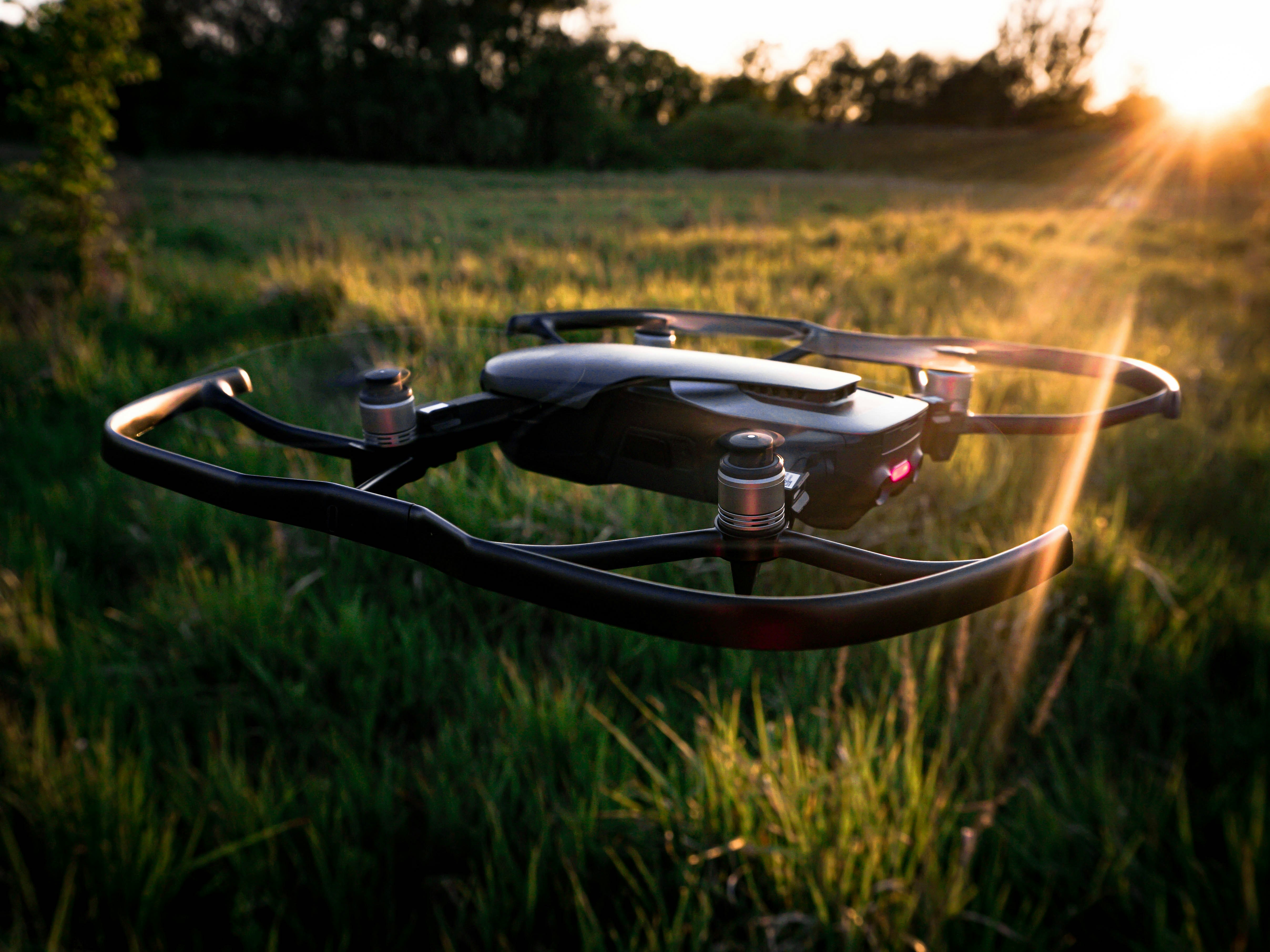 Black and red drone in green field photo – Free Nature Image on Unsplash