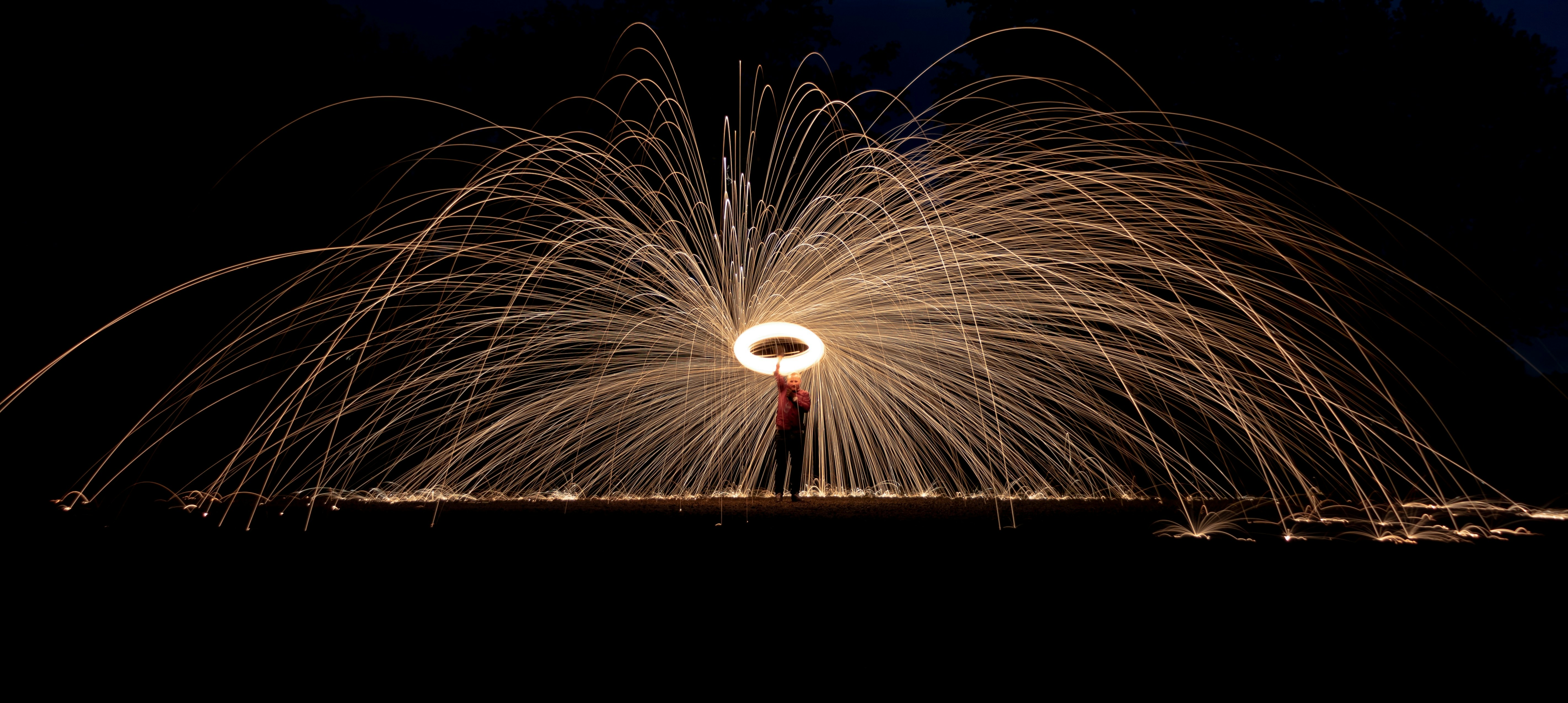 Halo of Sparks: A Nightsteel Spin Encircles a Lone Figure
