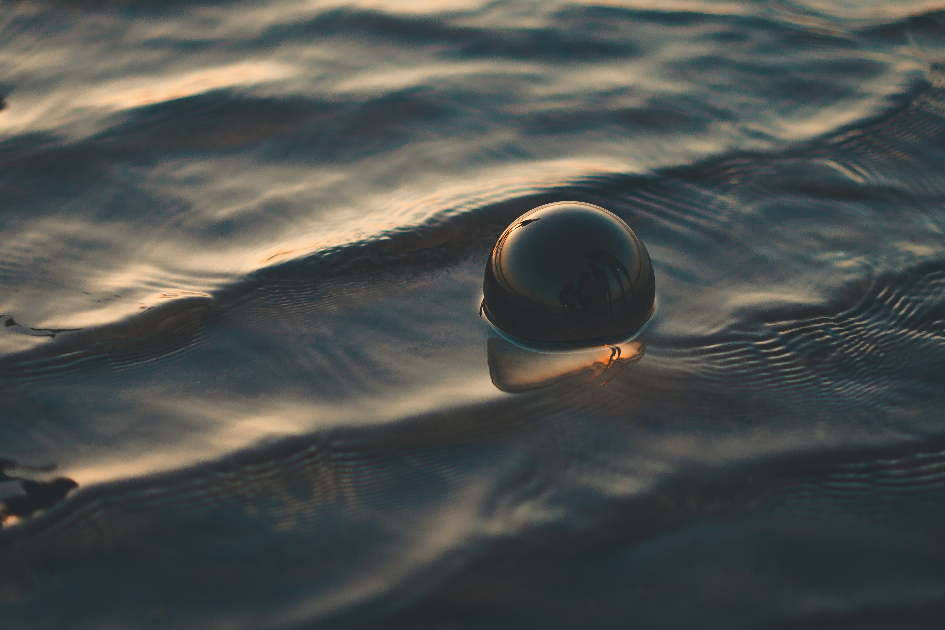 Dusk-Ripple Sphere: A Glass Ball Resting on Quiet Water