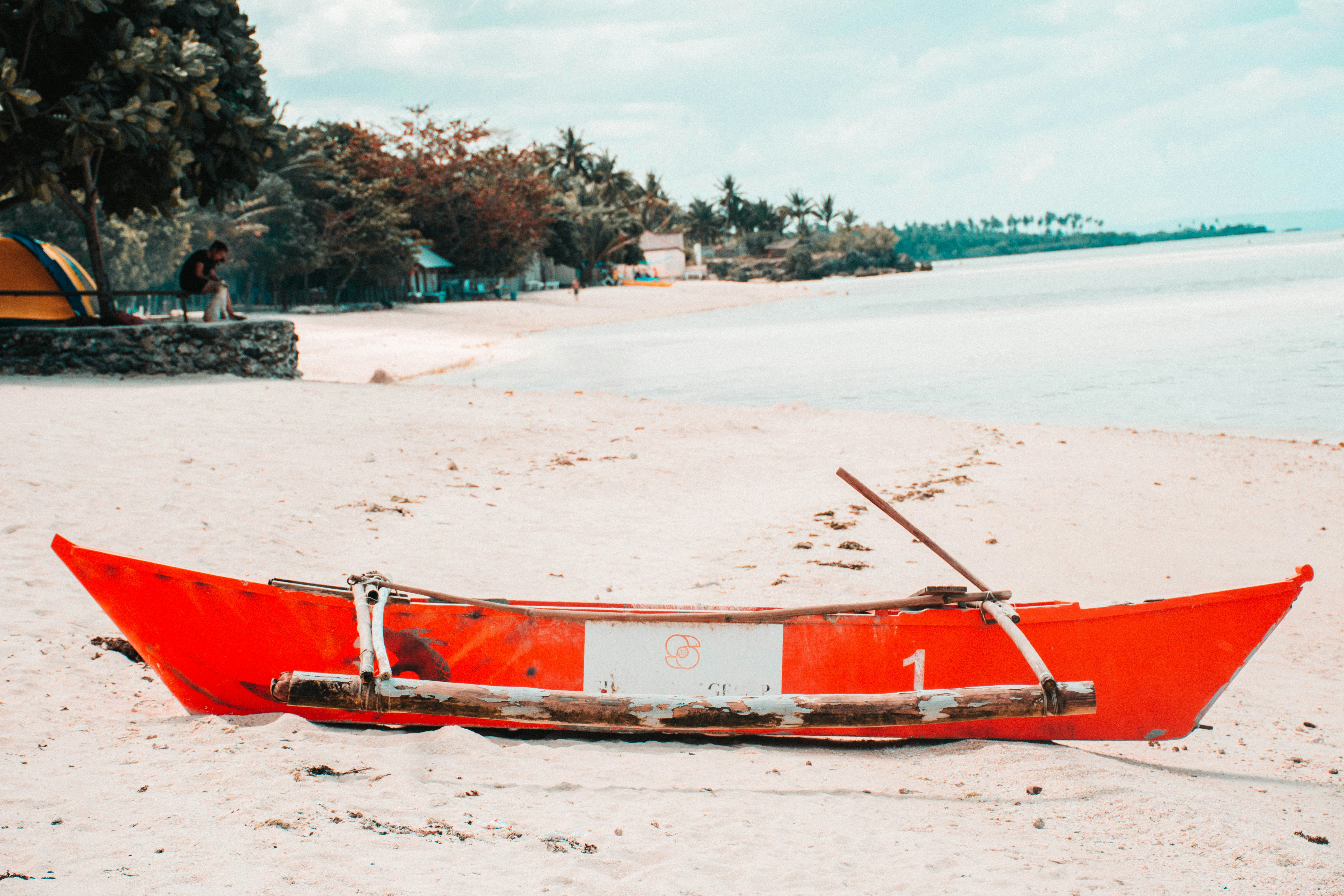 Red Boat on a Quiet Beach: Stillness in a Tropical Dawn