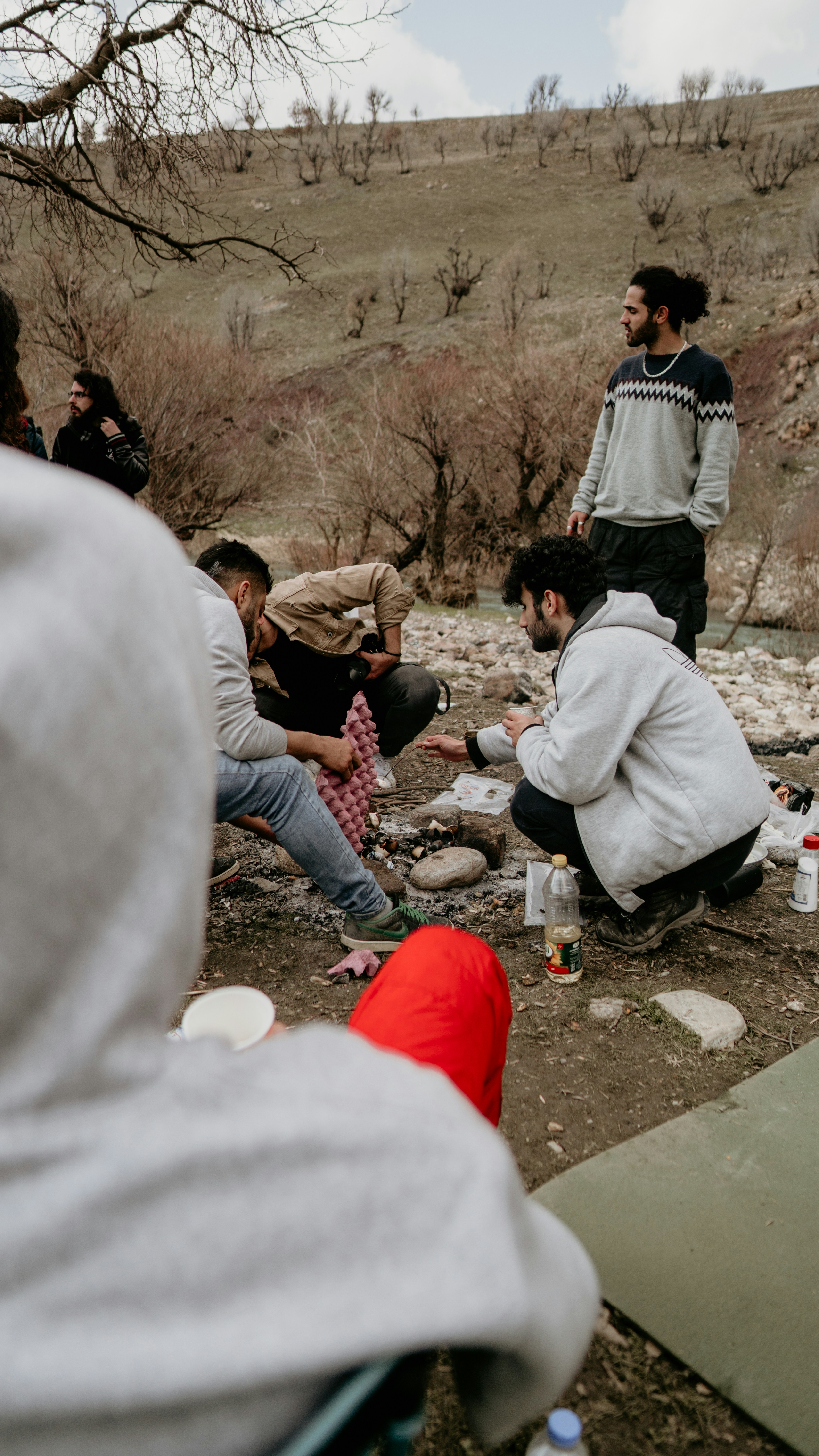 Gathering Around the Fire: A Candid Outdoor Moment