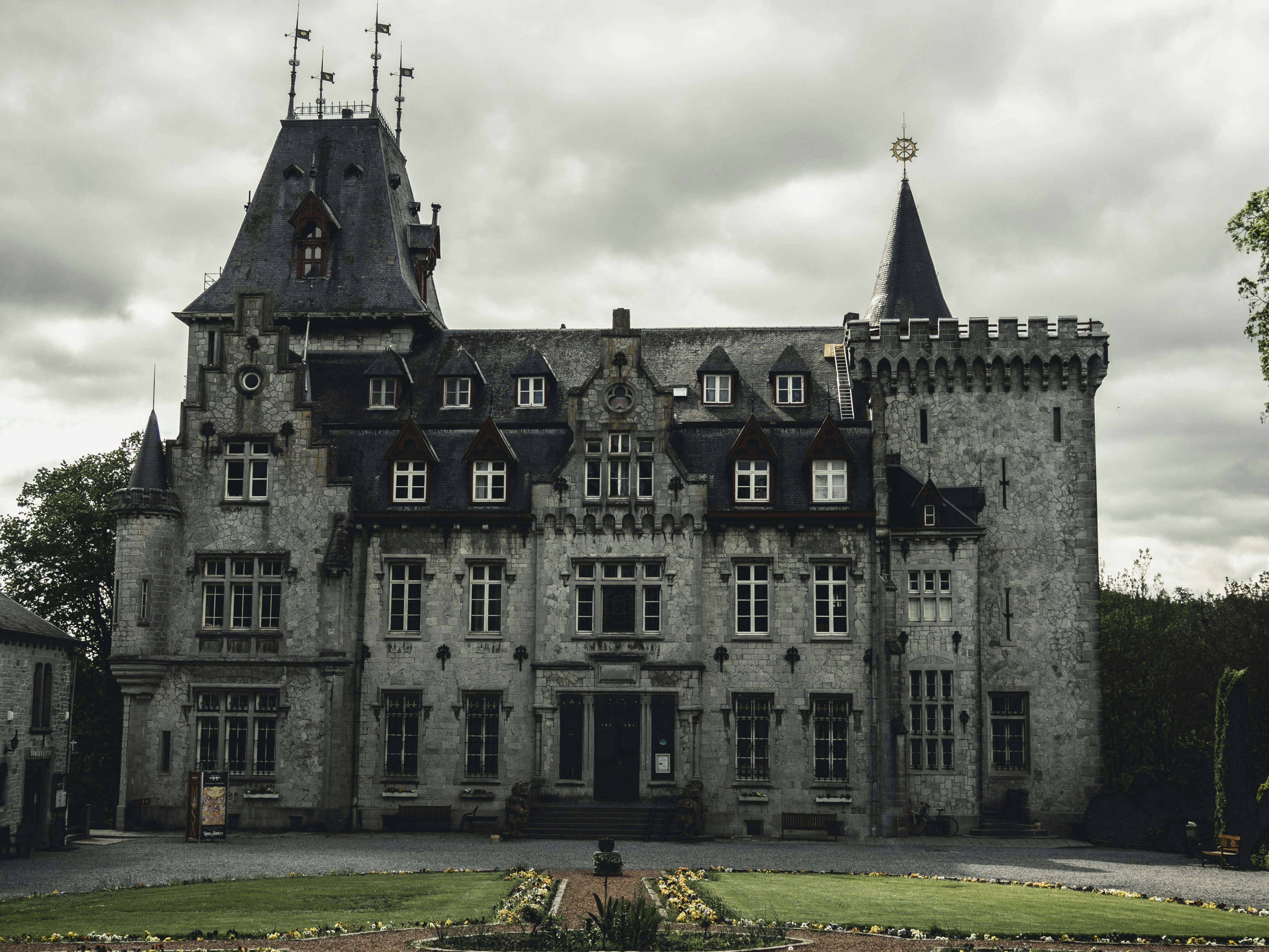 Low-angle photography of brown concrete 2-storey building between trees ...