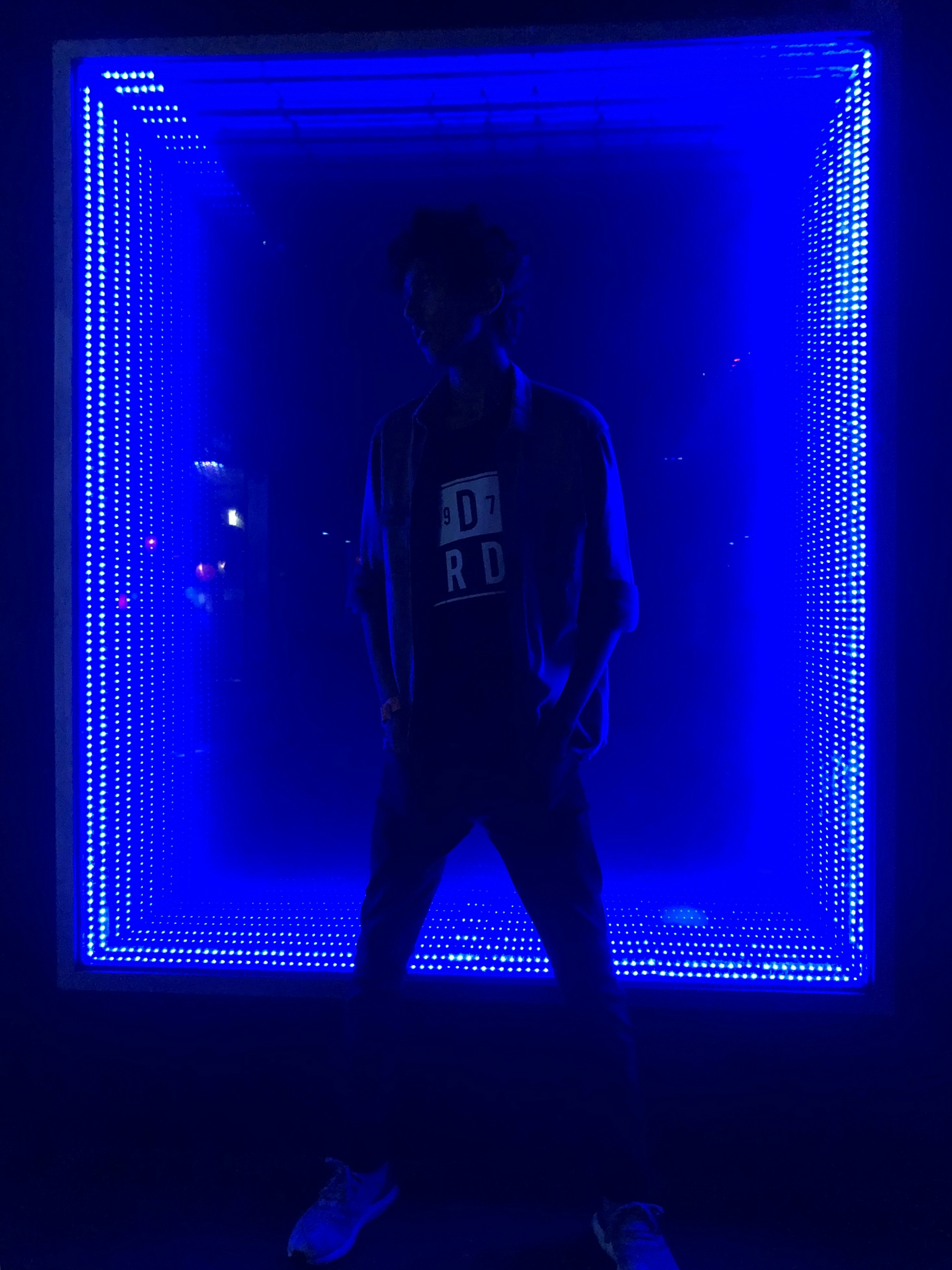 Cyan Neon Cube Portrait: A Shadowed Figure in Electric Stillness
